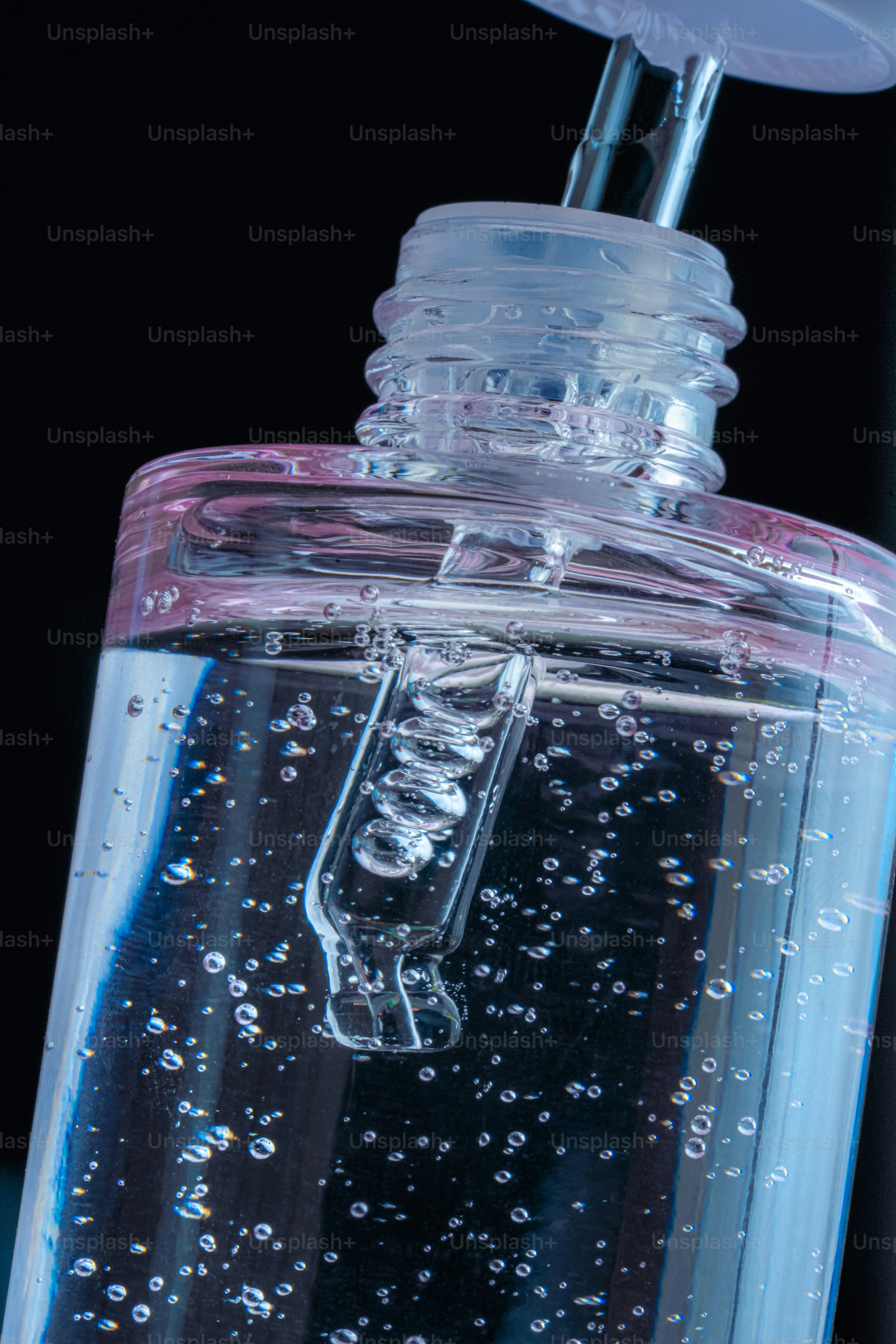 A pipette extracts liquid from a serum bottle. photo – Blue Image on ...