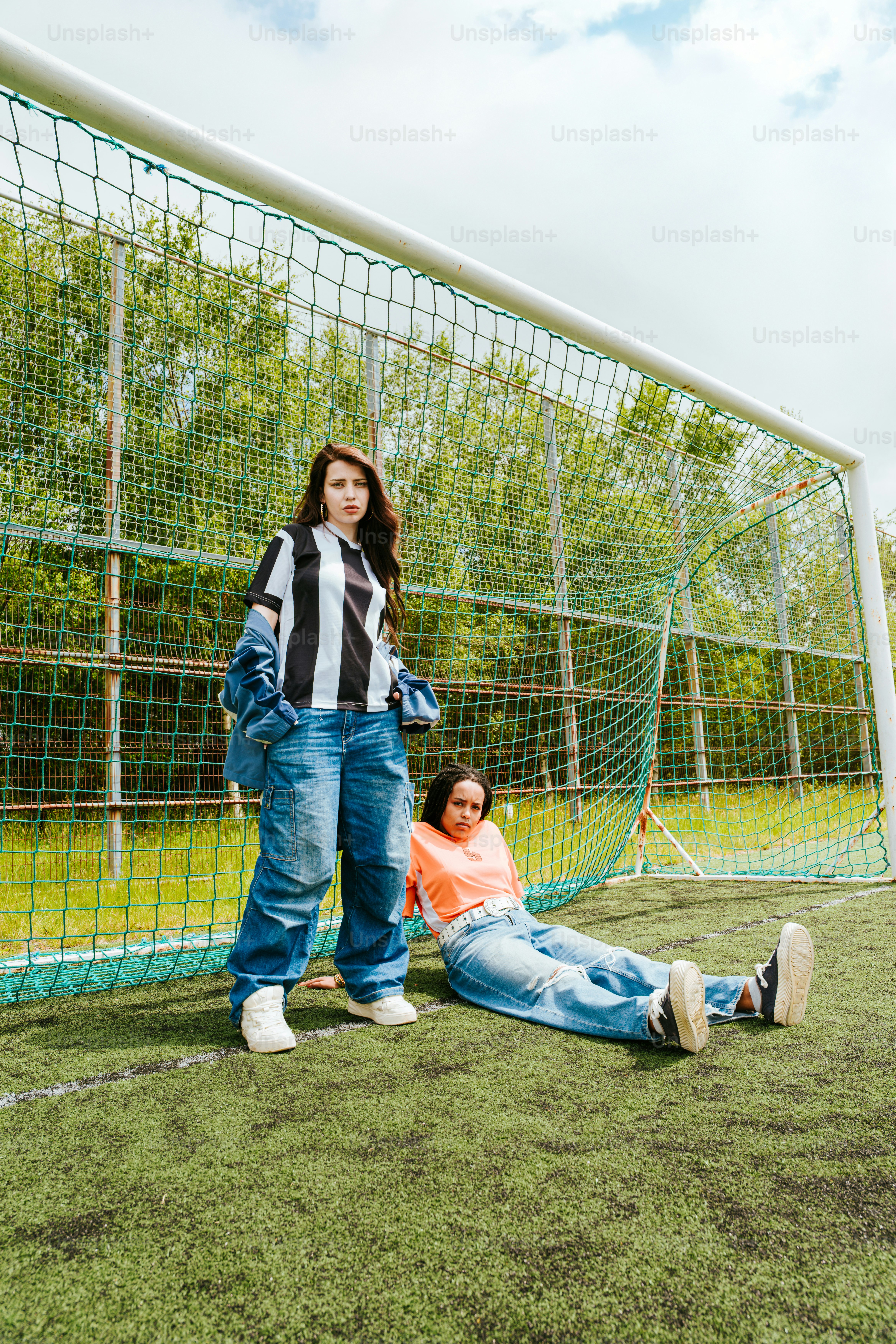 Two people are leaning over a railing. photo – Fashion Image on Unsplash