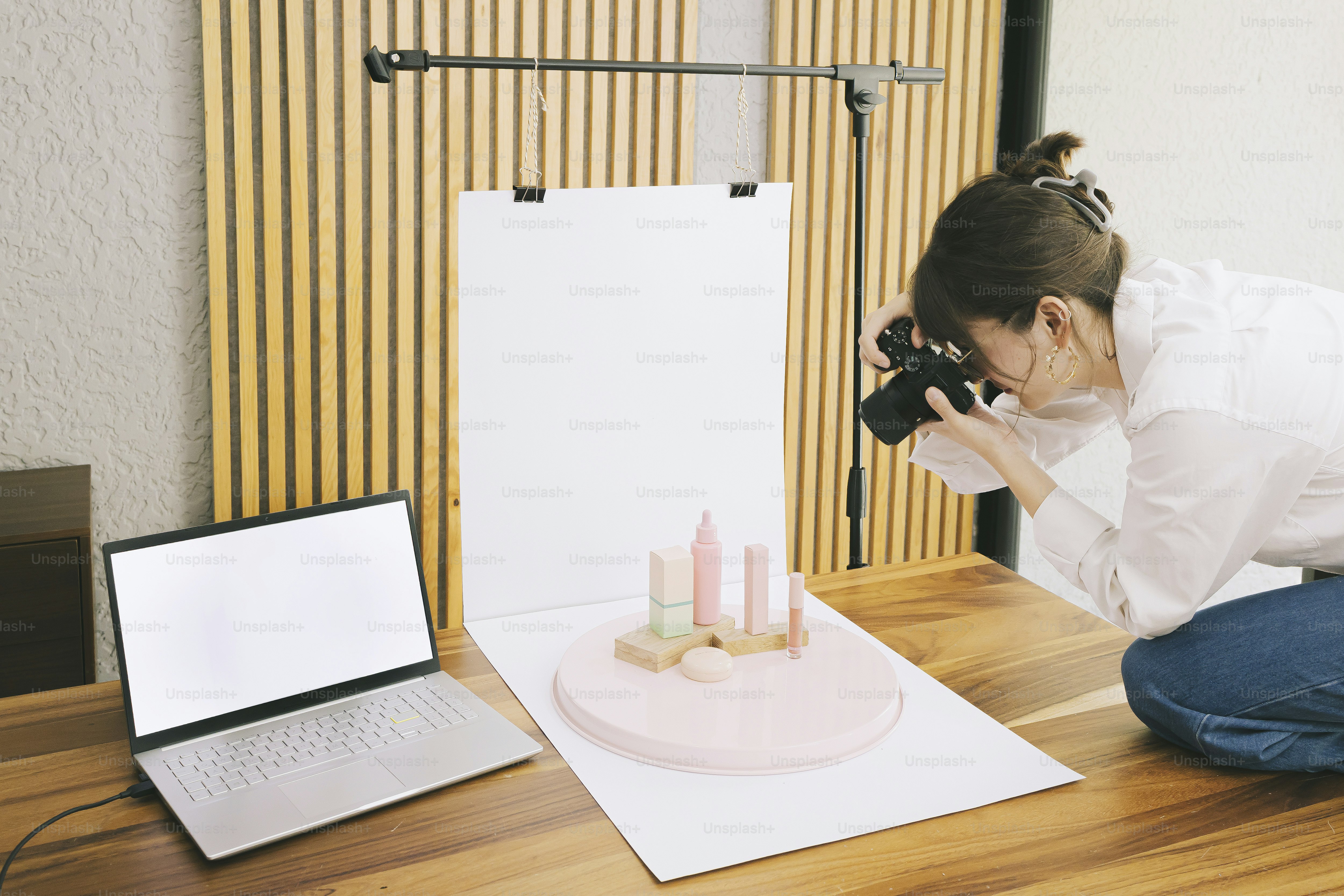 Photographer takes pictures of products on a table. photo – Small ...