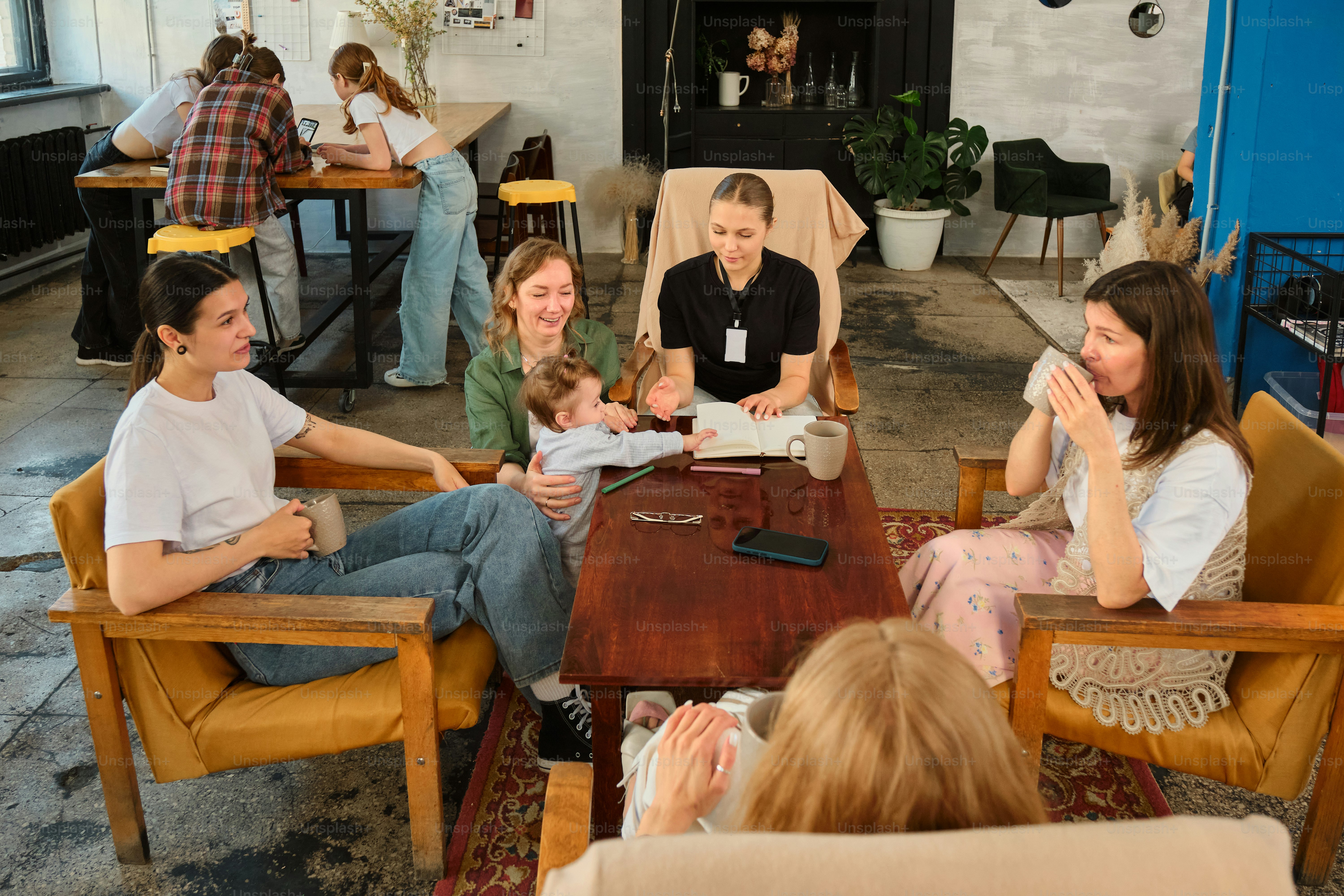 People sit around a table in a meeting. photo – Community space Image ...
