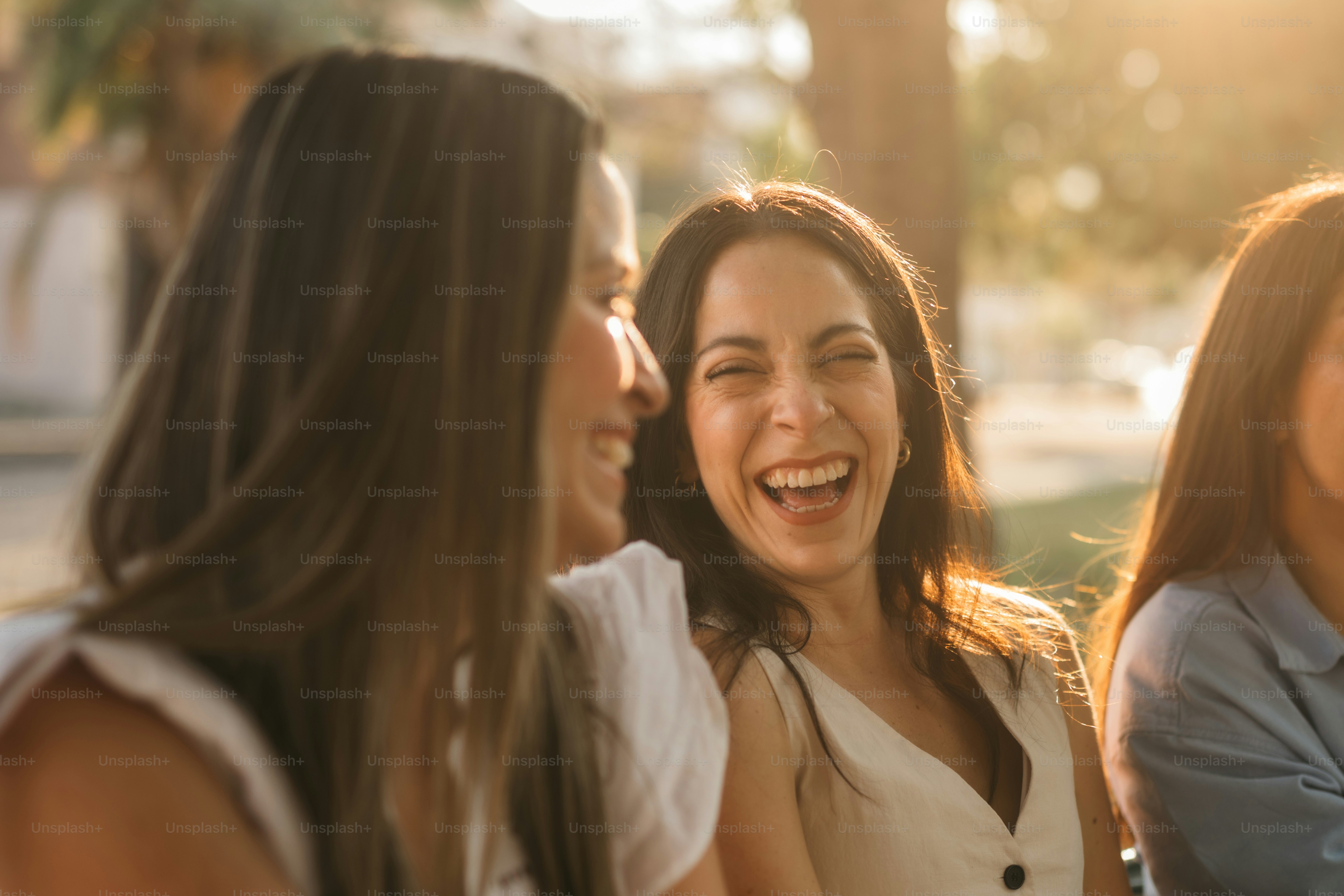 Happy women laugh together outside in the sunshine. photo – Portrait ...