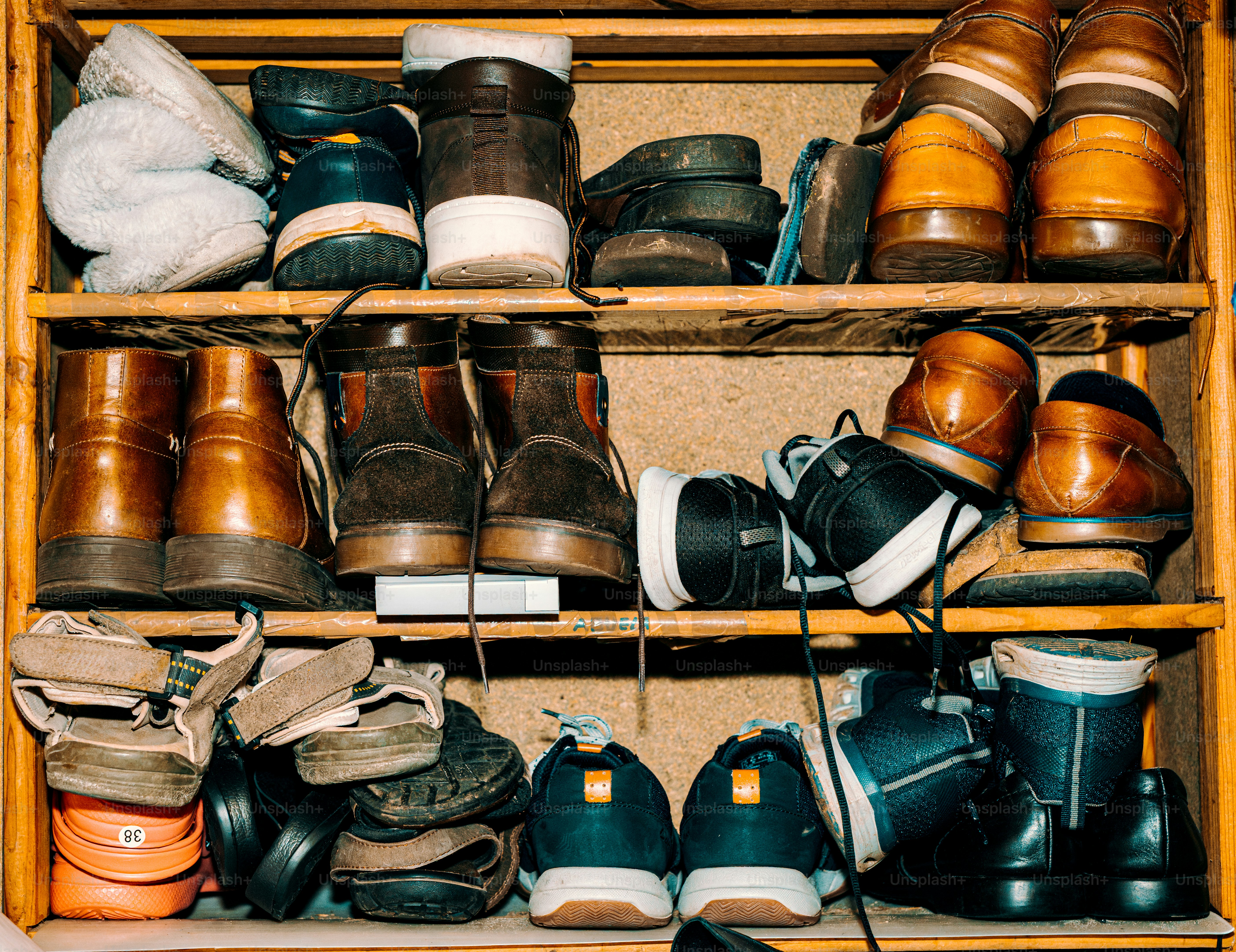 Shelves are overflowing with various shoes. photo – Shoes Image on Unsplash