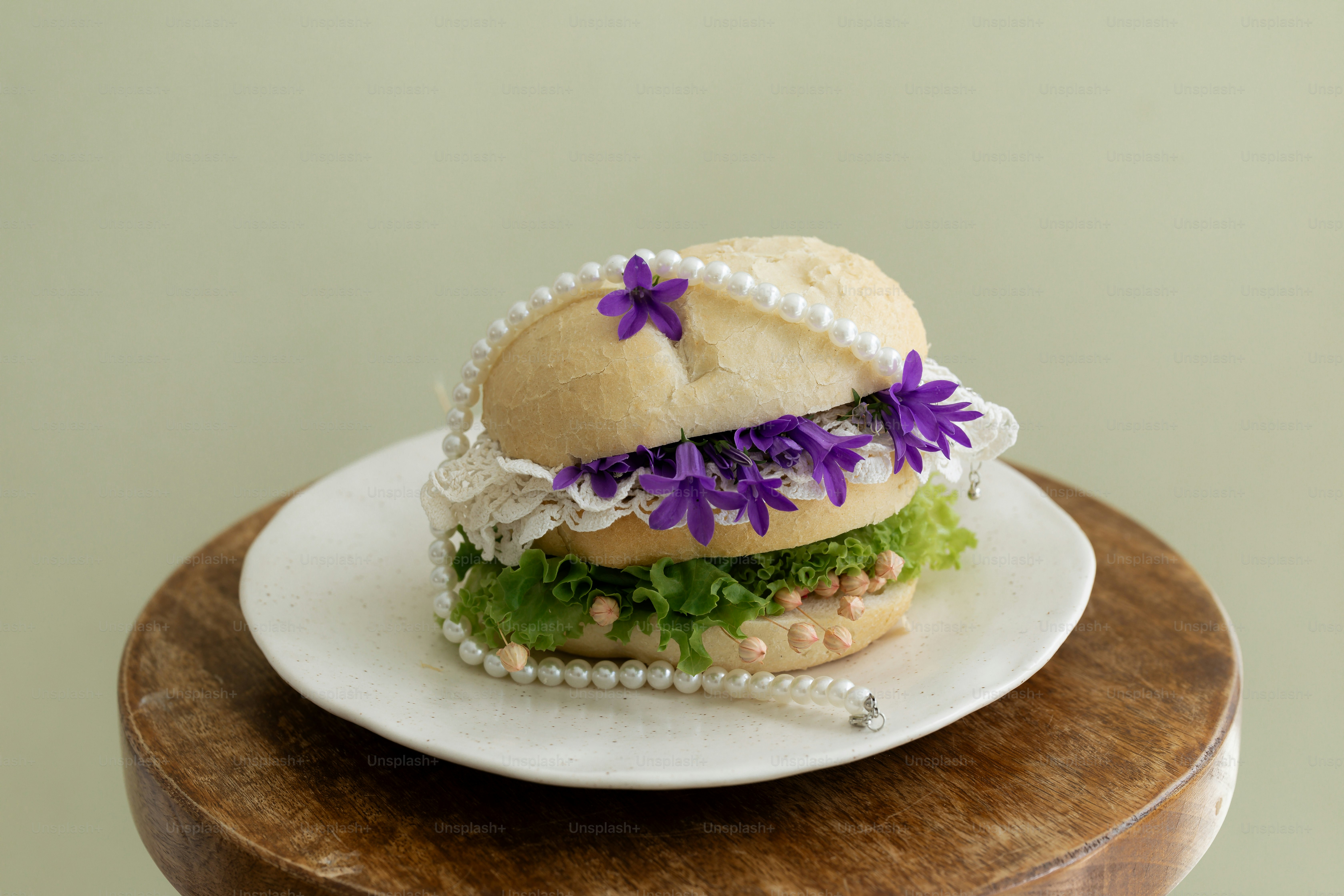 A fancy burger decorated with pearls and flowers. photo – Surprise ...