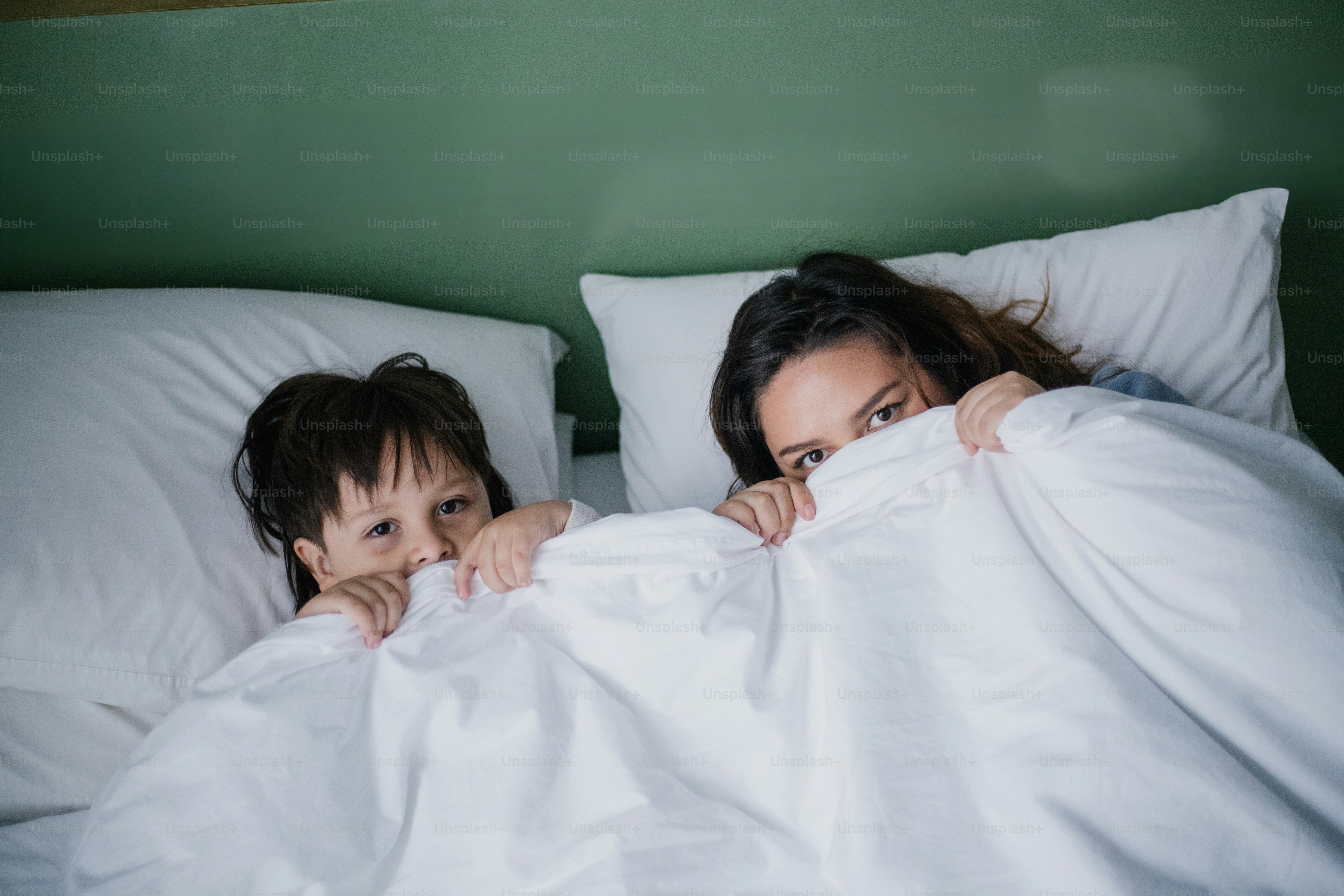 Two people hide under a blanket, peeking out. photo – Travel Image on ...