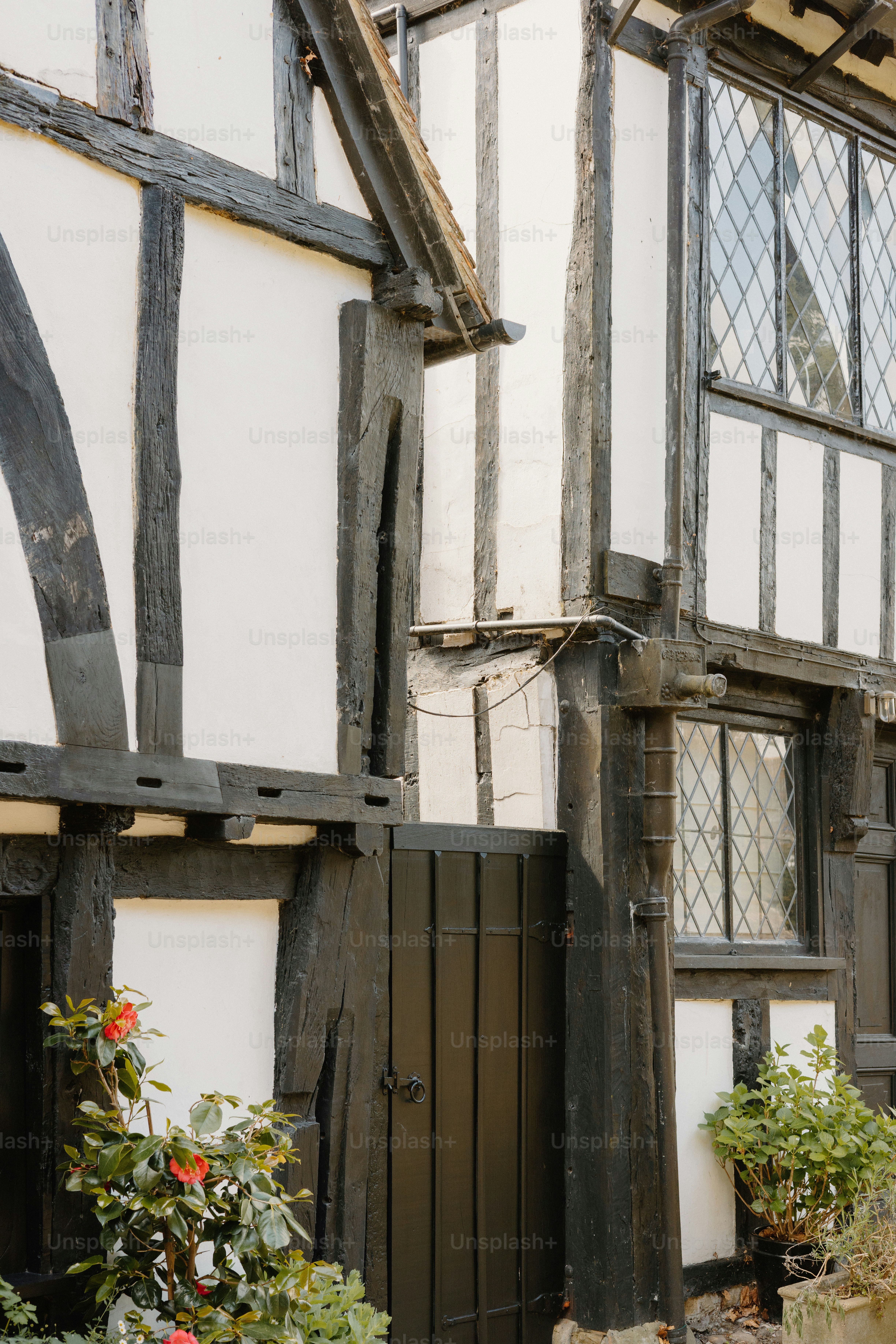 An old building showcases timber framing and decorative windows. photo ...