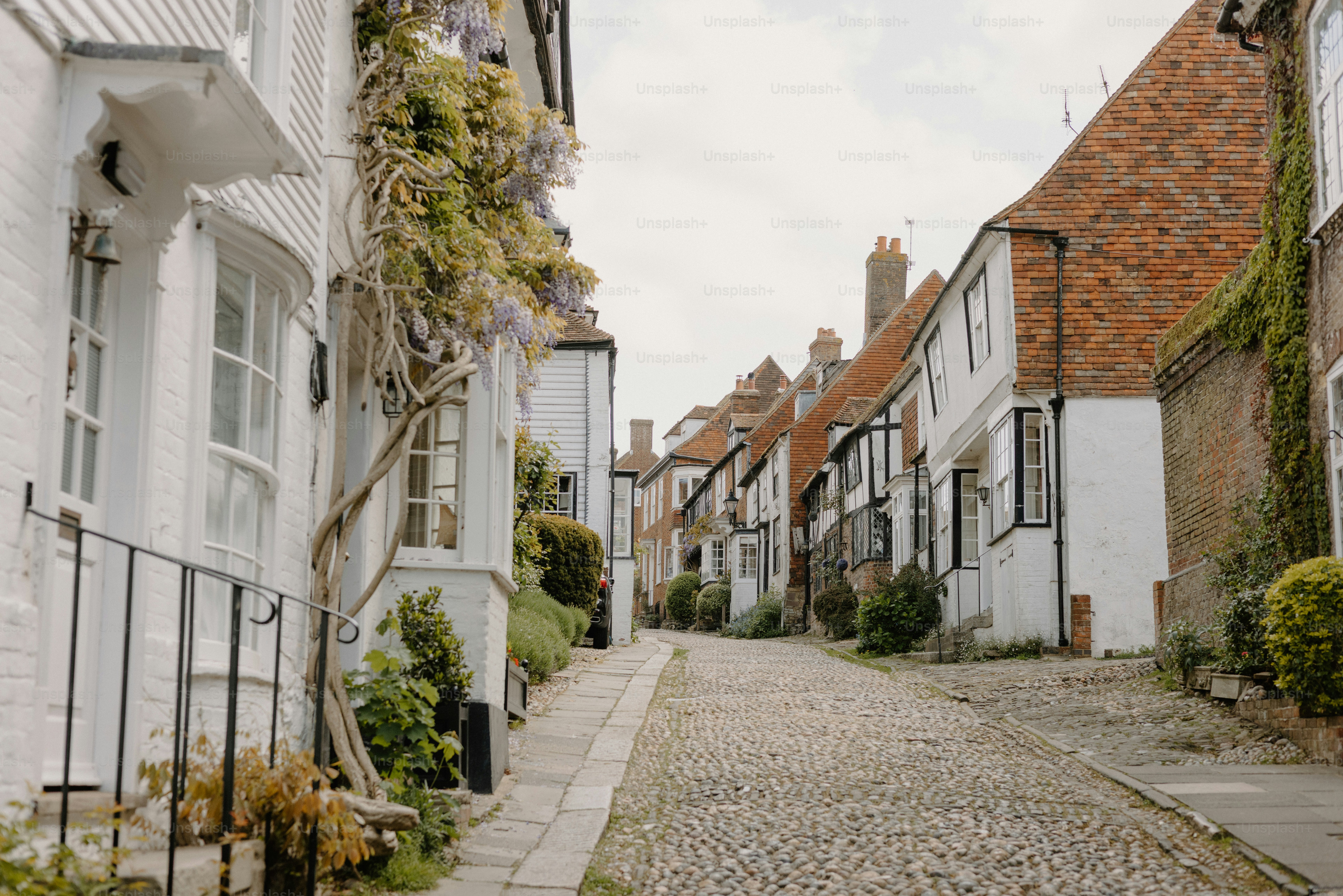 British flags adorn a historic cobblestone street. photo – Street Image ...