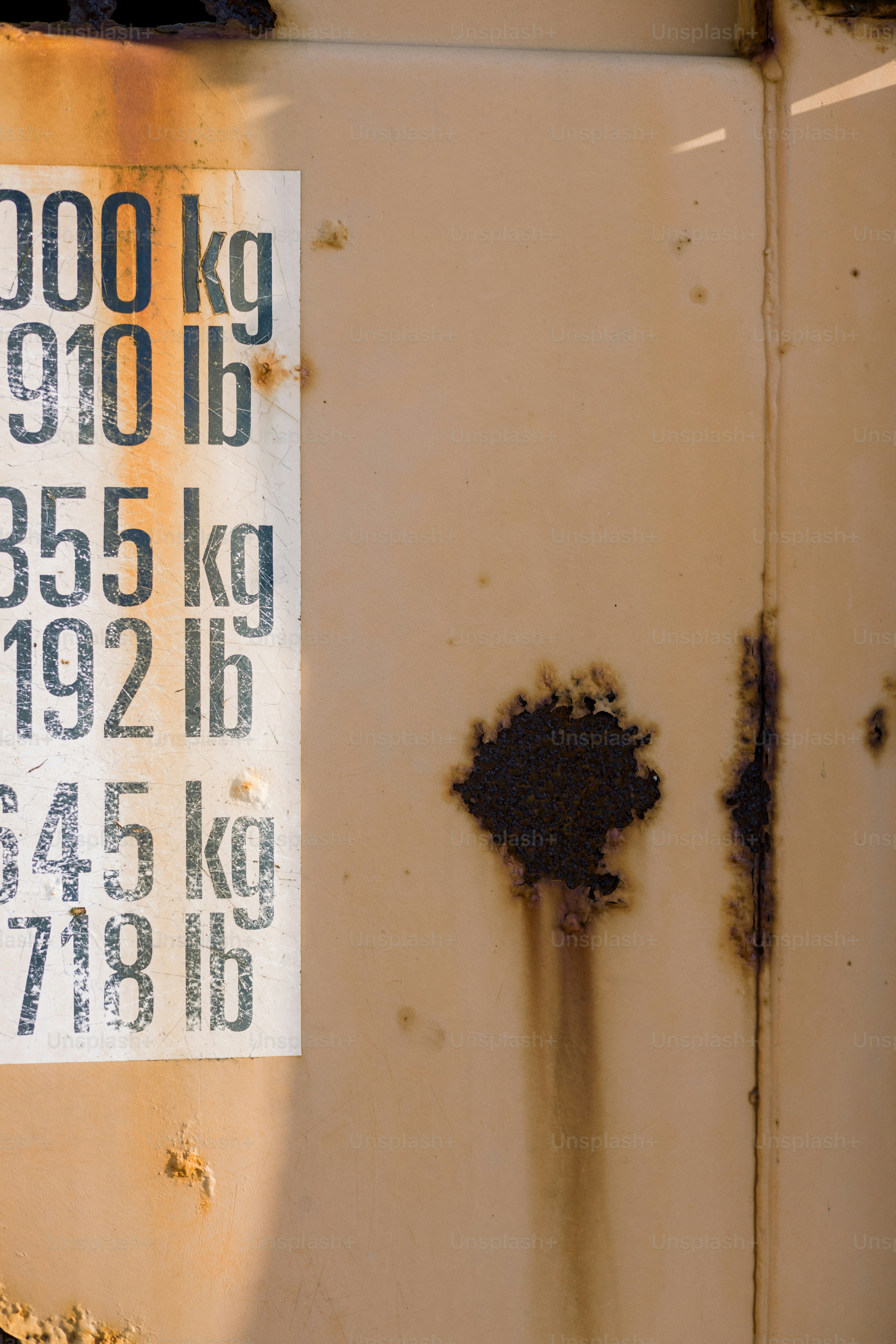 Rust and weight markings on a metal surface. photo – Background Image ...