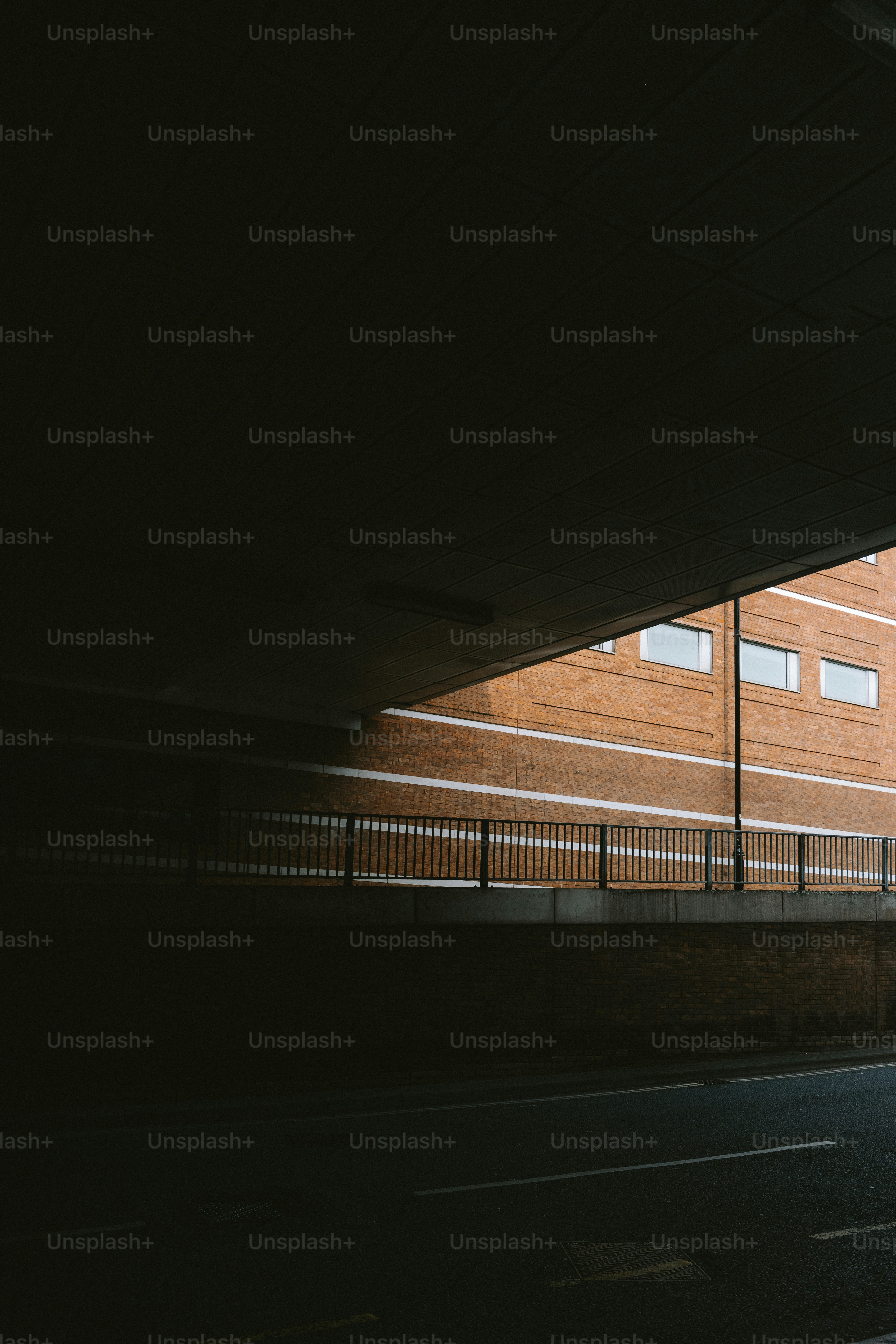 Underpass with brick building and road. photo – Street photography ...