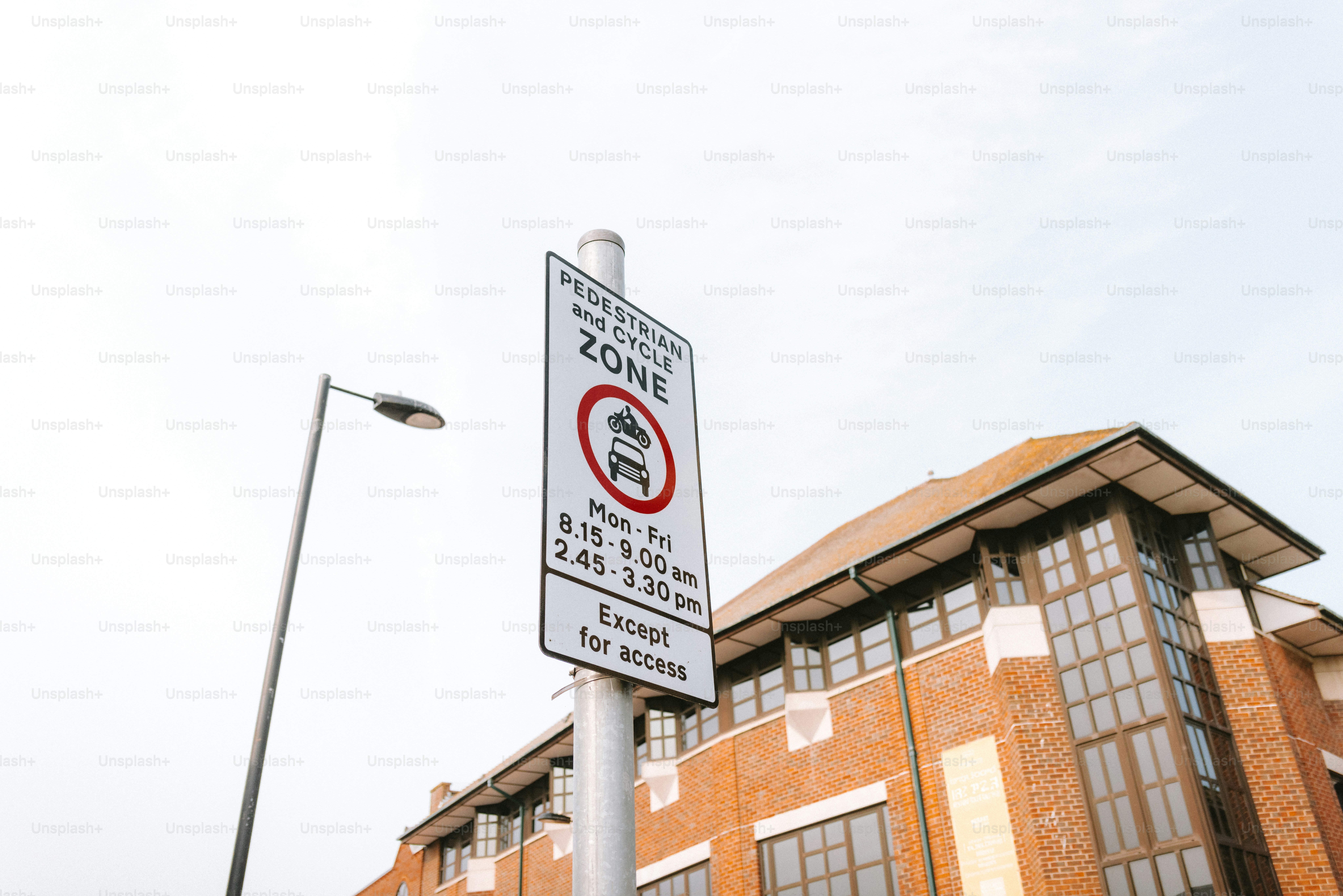 A pedestrian and school zone traffic sign. photo – Image on Unsplash