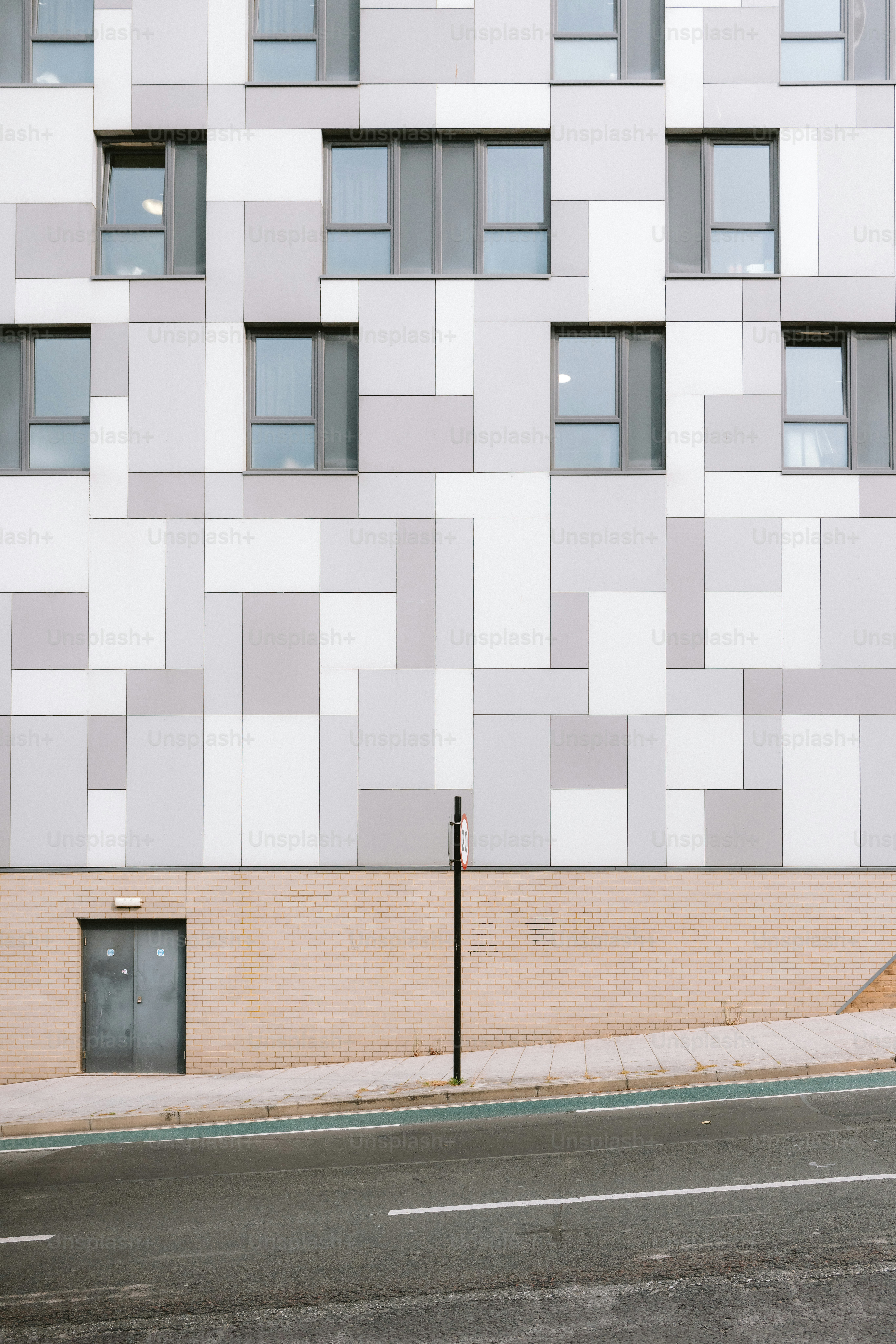 A modern building with patterned panels and windows. photo – Building ...