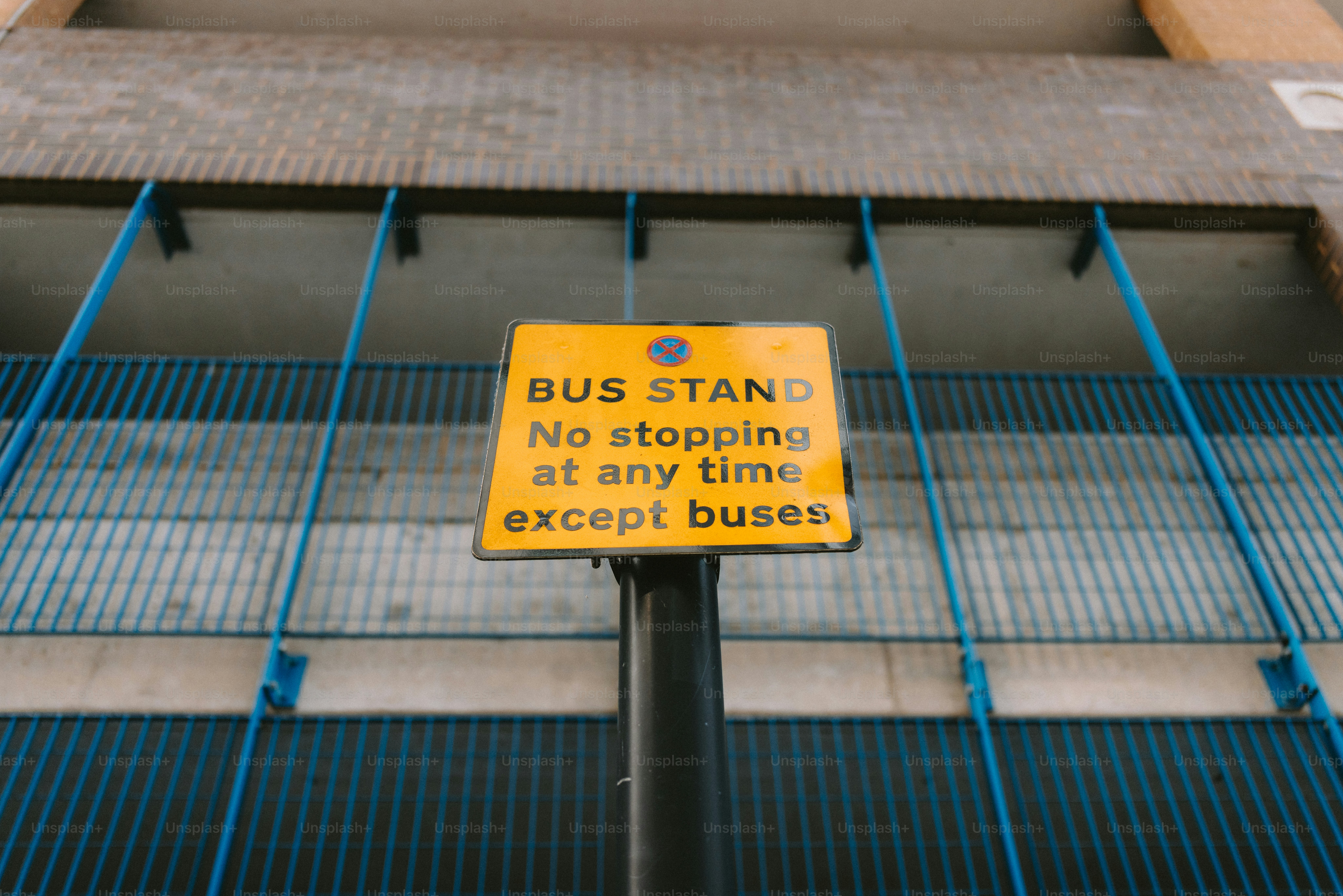 A bus stand sign with instructions about stopping. photo – Outdoors ...