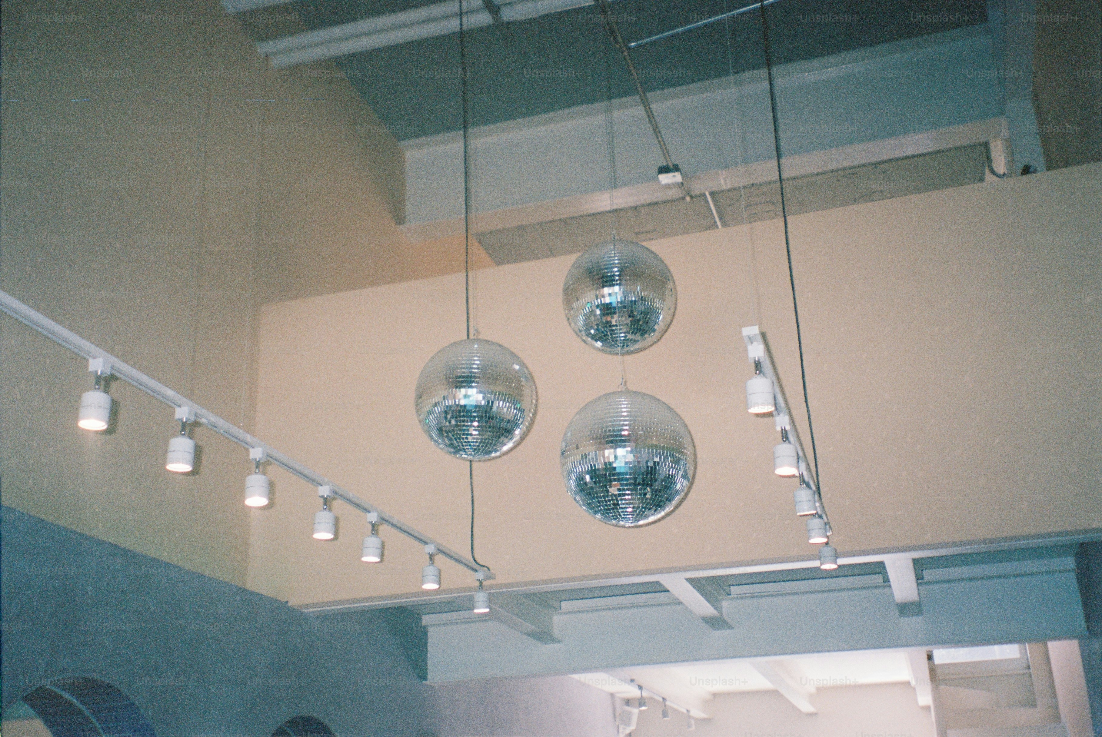 Three disco balls hang from the ceiling. photo – Film photography Image ...