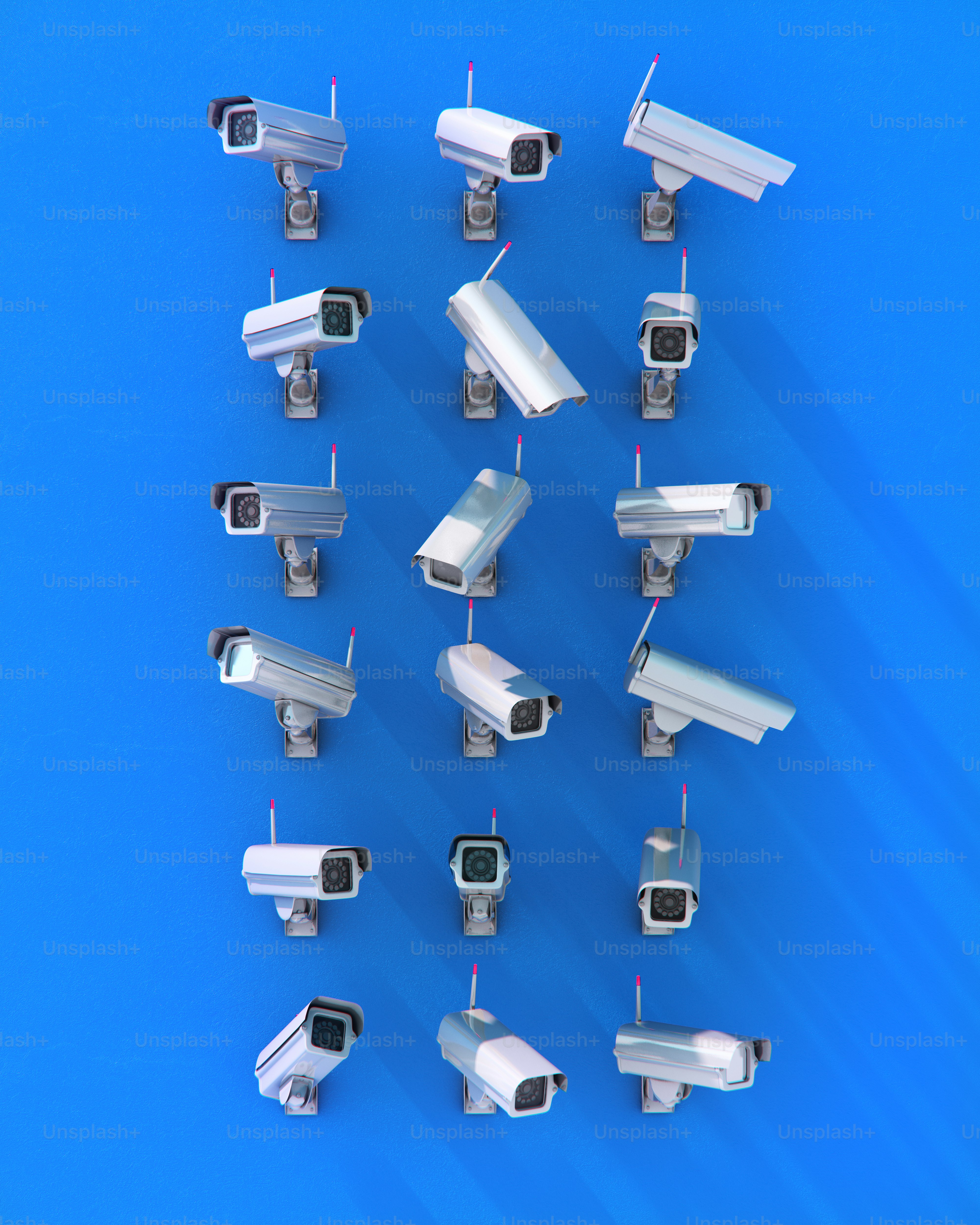 Surveillance cameras mounted on a bright blue wall. photo – Security ...