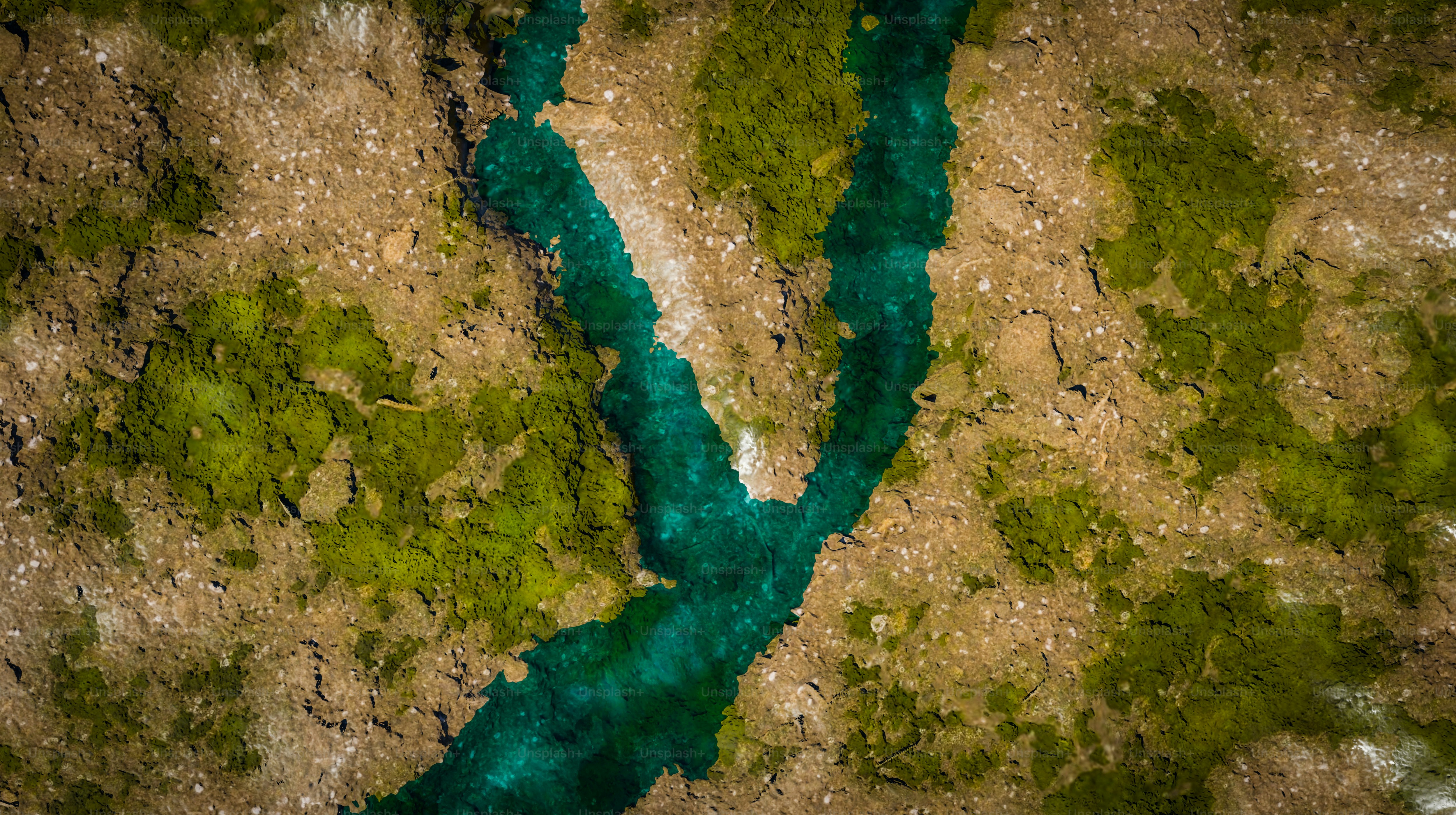 Aerial view of a teal river flowing through land. photo – 3d render ...
