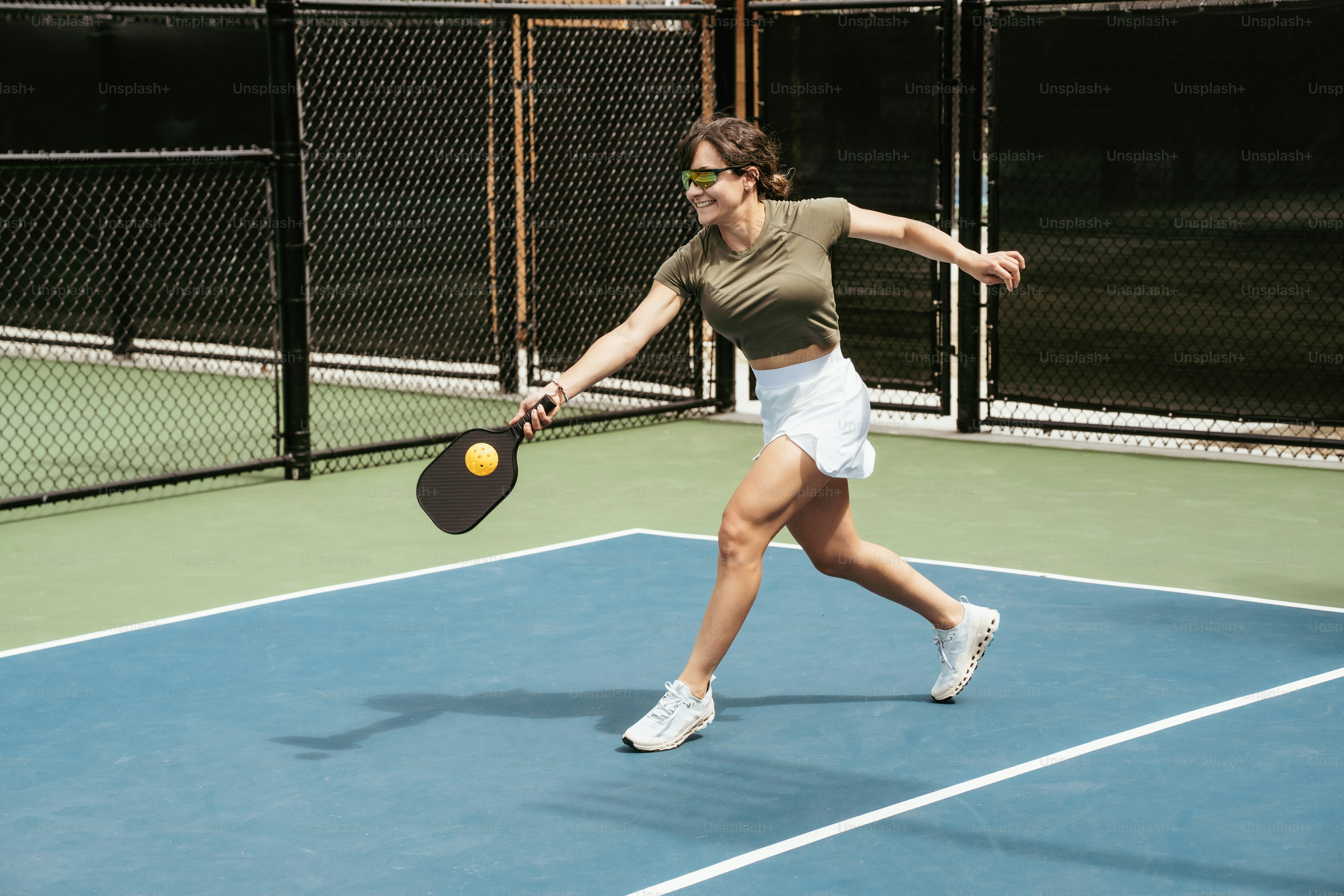 Woman playing pickleball with a powerful swing. photo – Sports Image on ...