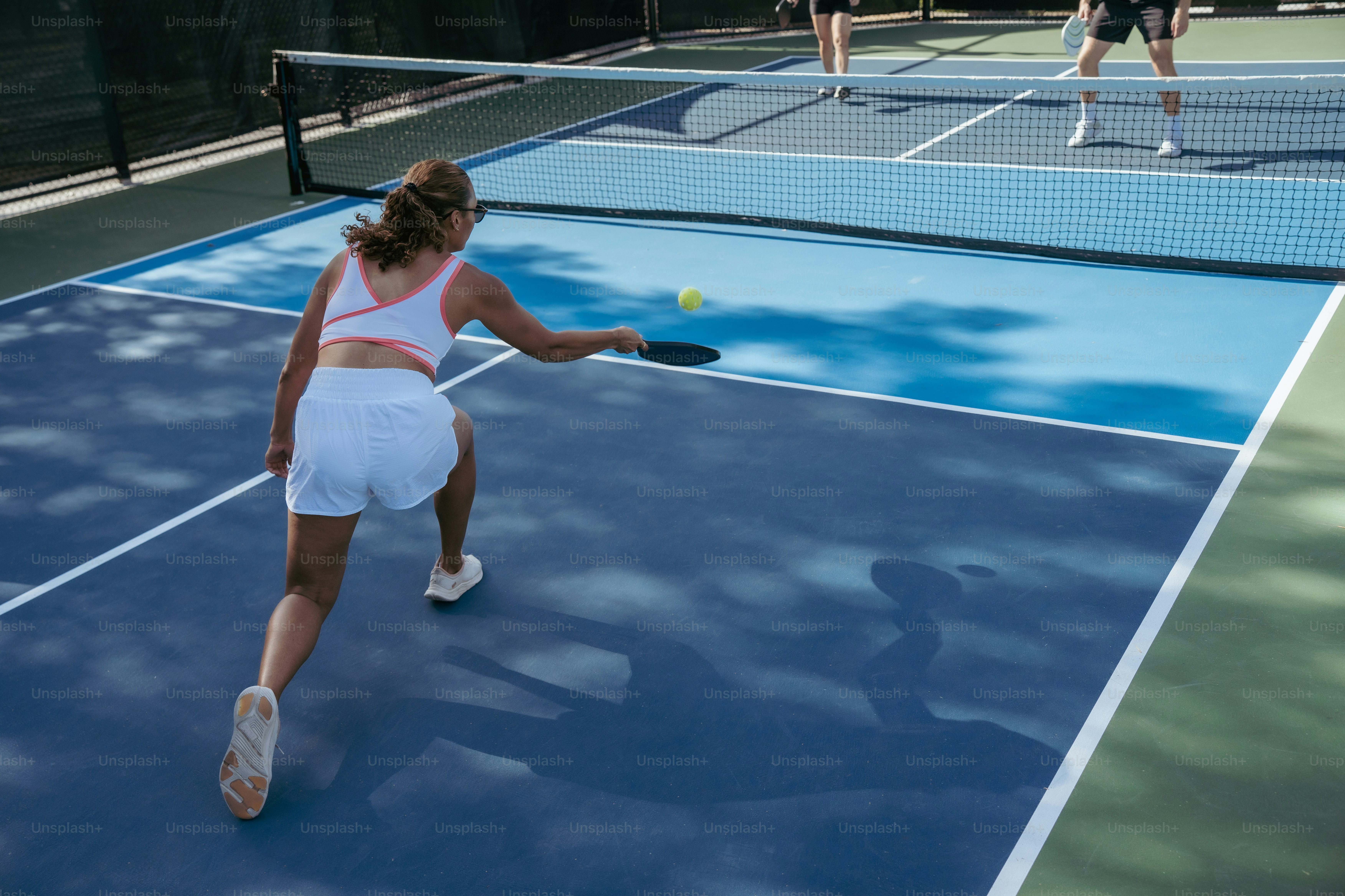 People are playing pickleball on an outdoor court. photo – Sports Image ...