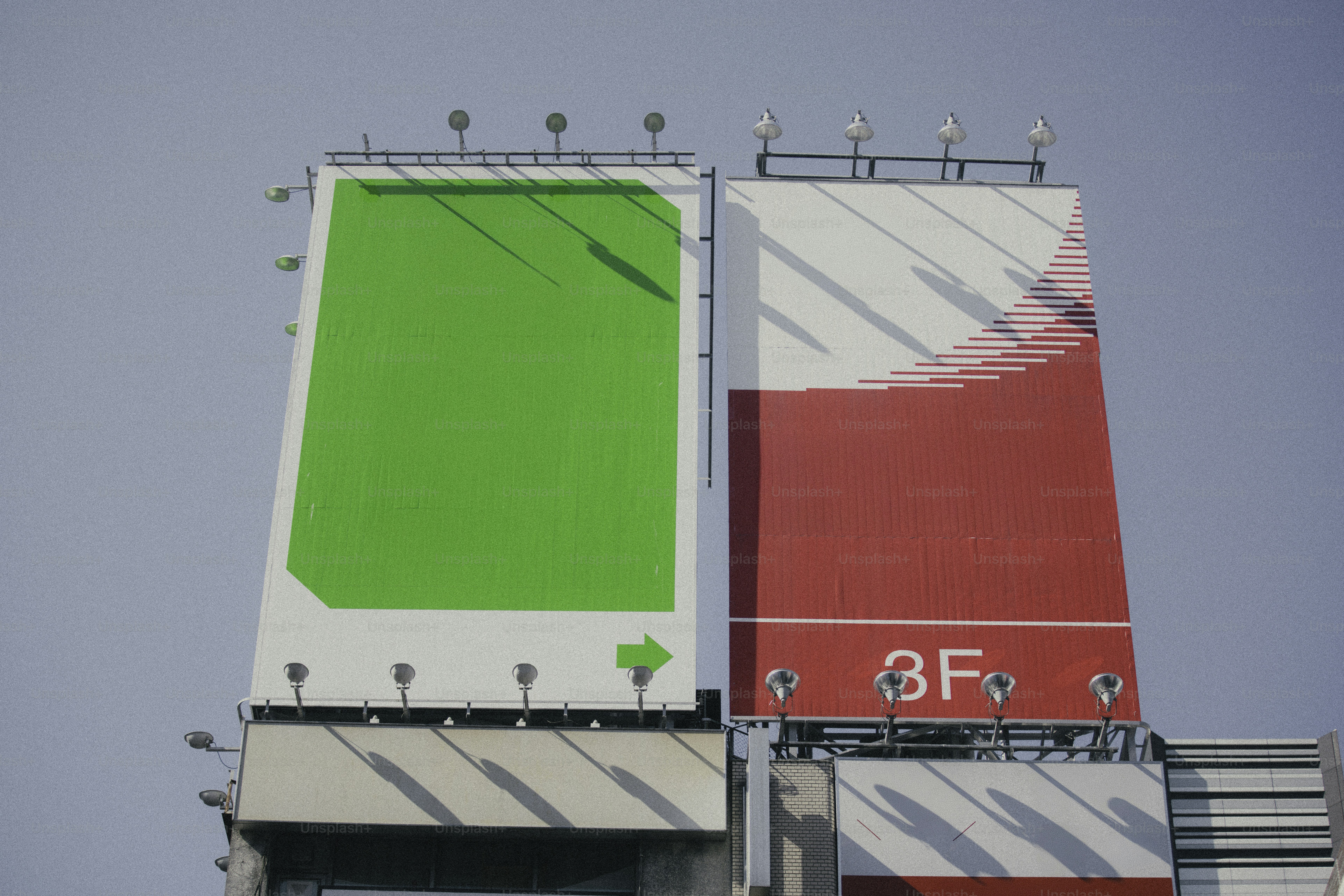Two billboards with colorful designs stand tall. photo – City Image on ...