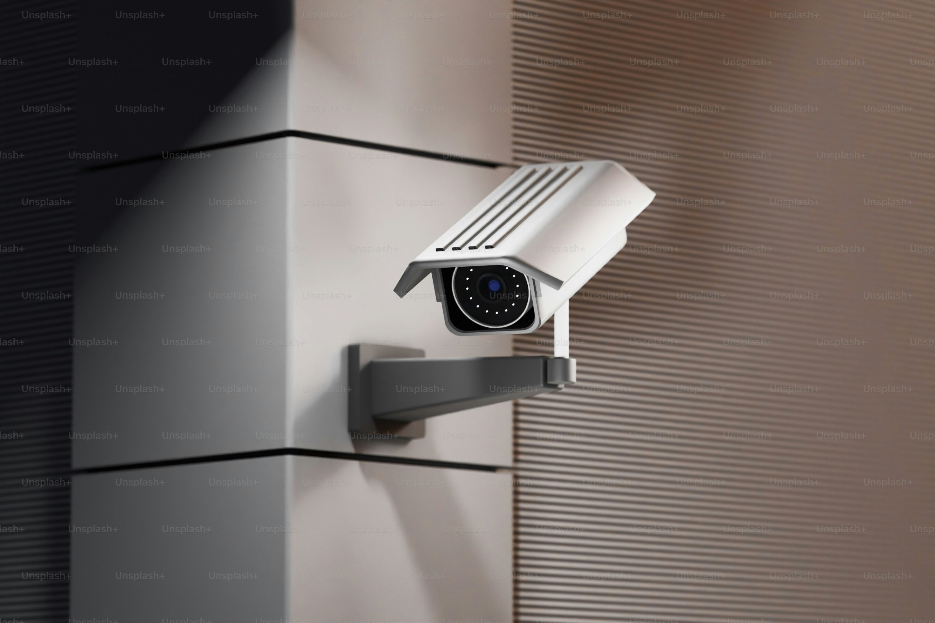 Security camera is mounted to a building wall. photo – Security Image ...