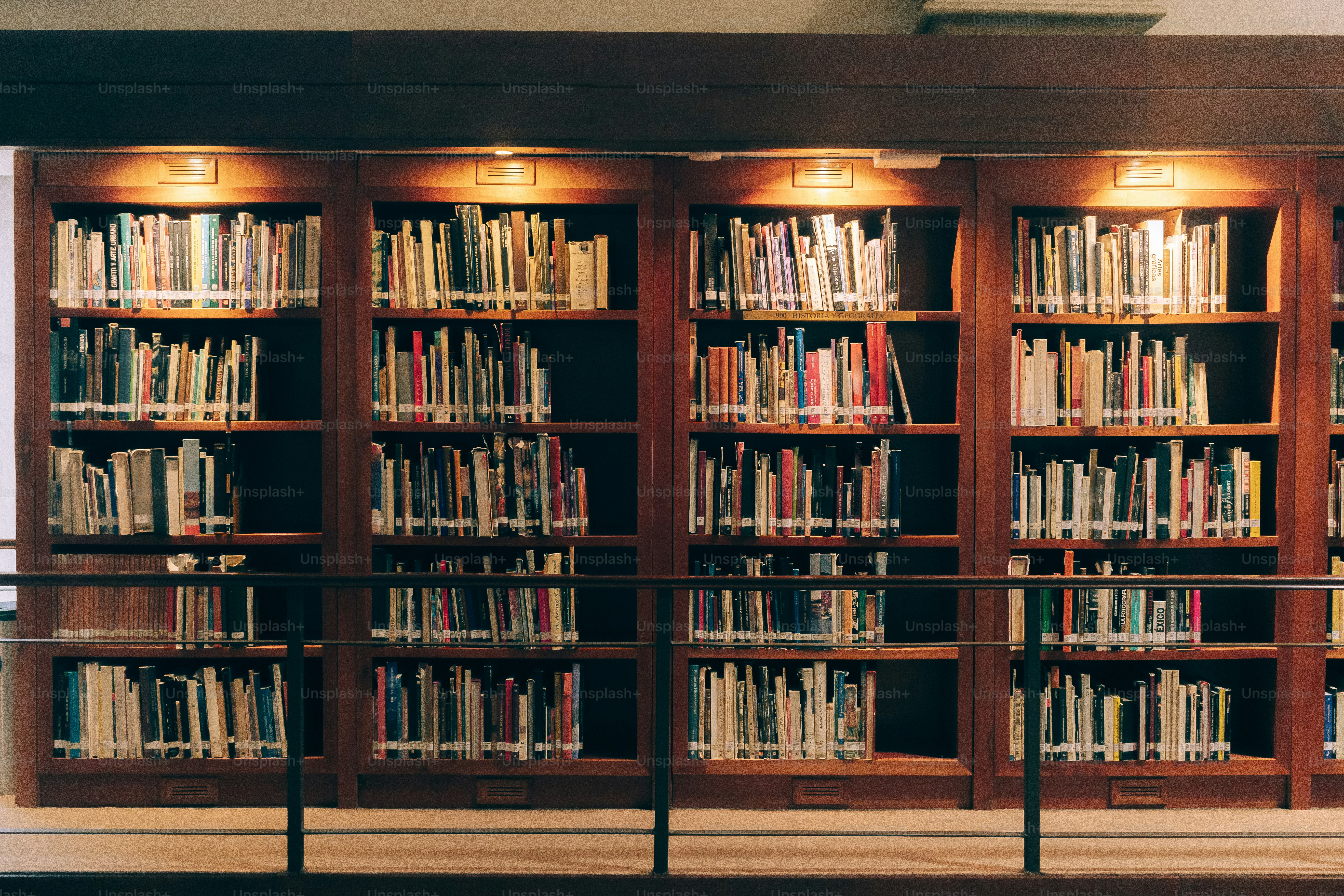 A library bookshelf filled with numerous books. photo – Books Image on ...