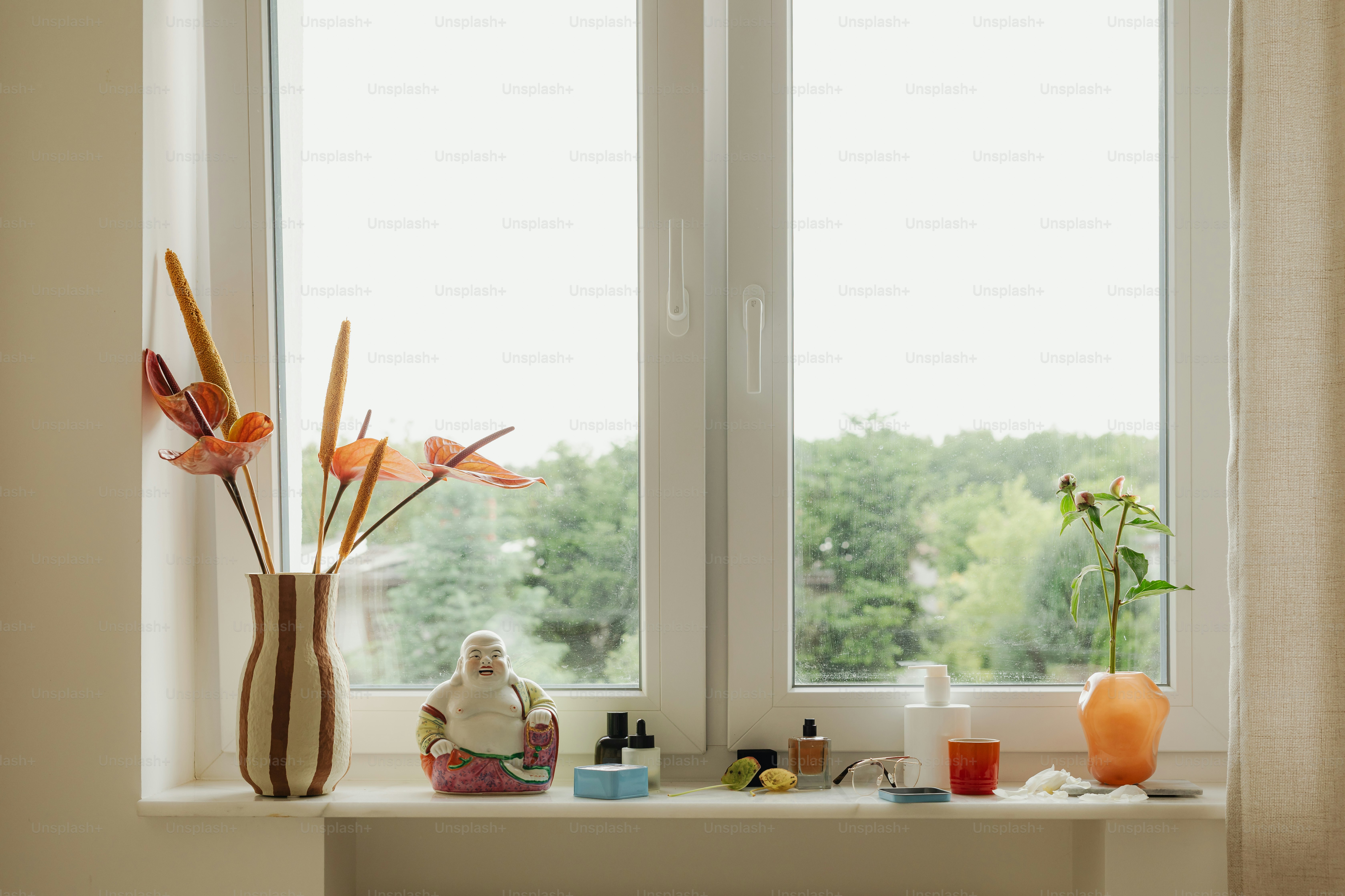 Window sill with flowers and decor overlooking trees. photo – Mess ...
