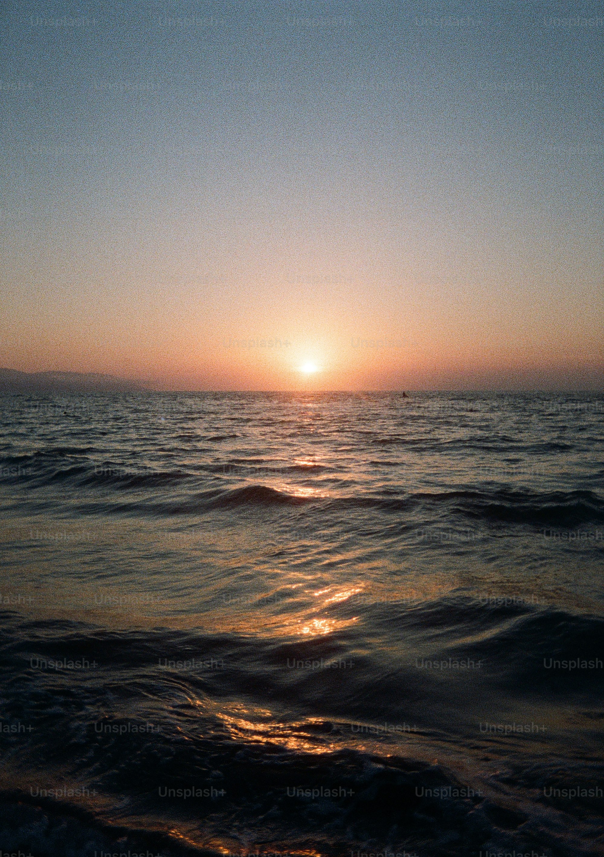 Sunset over ocean waves creates a beautiful scene. photo – Film ...