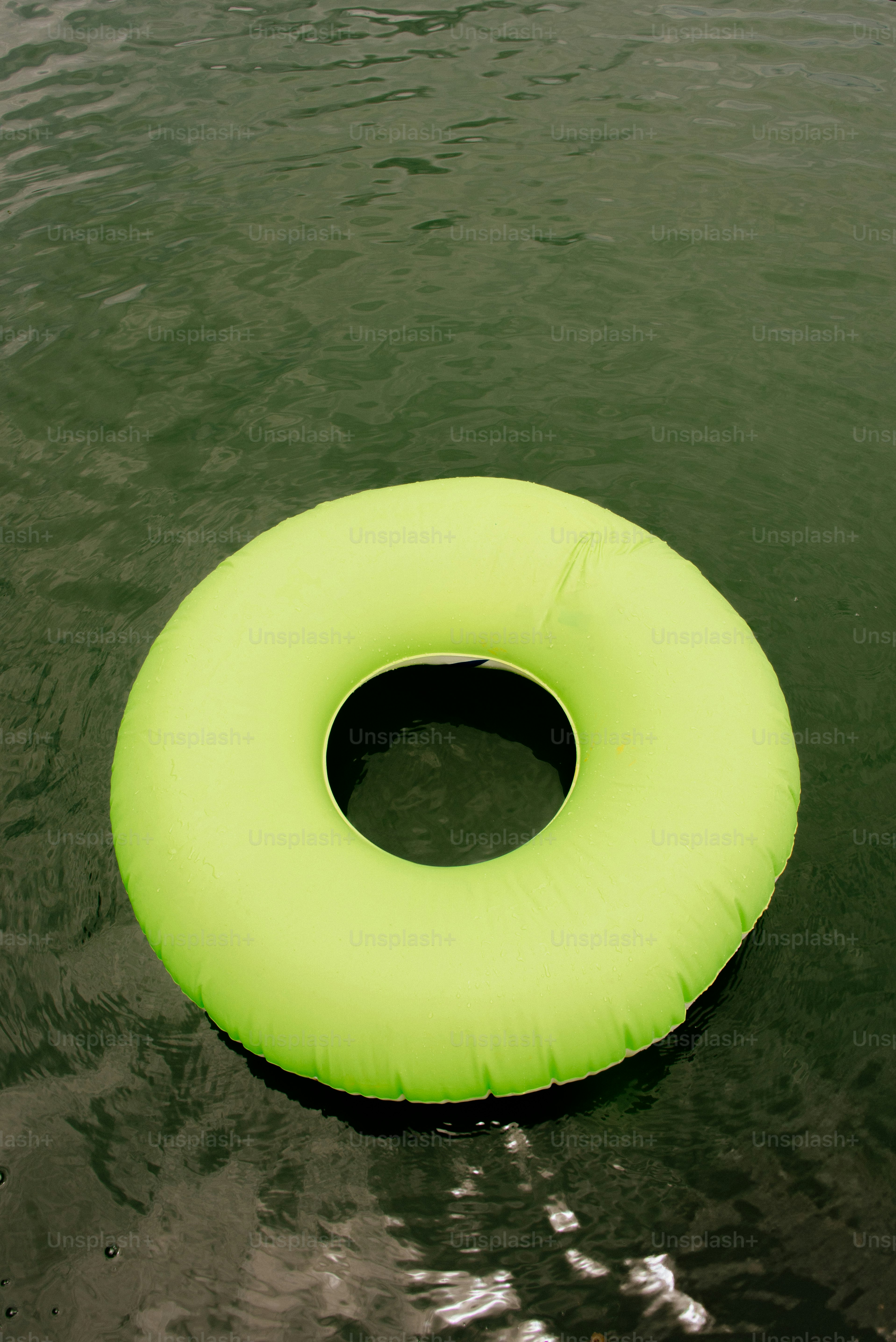 A colorful tube floats peacefully on water. photo – Summer Image on ...