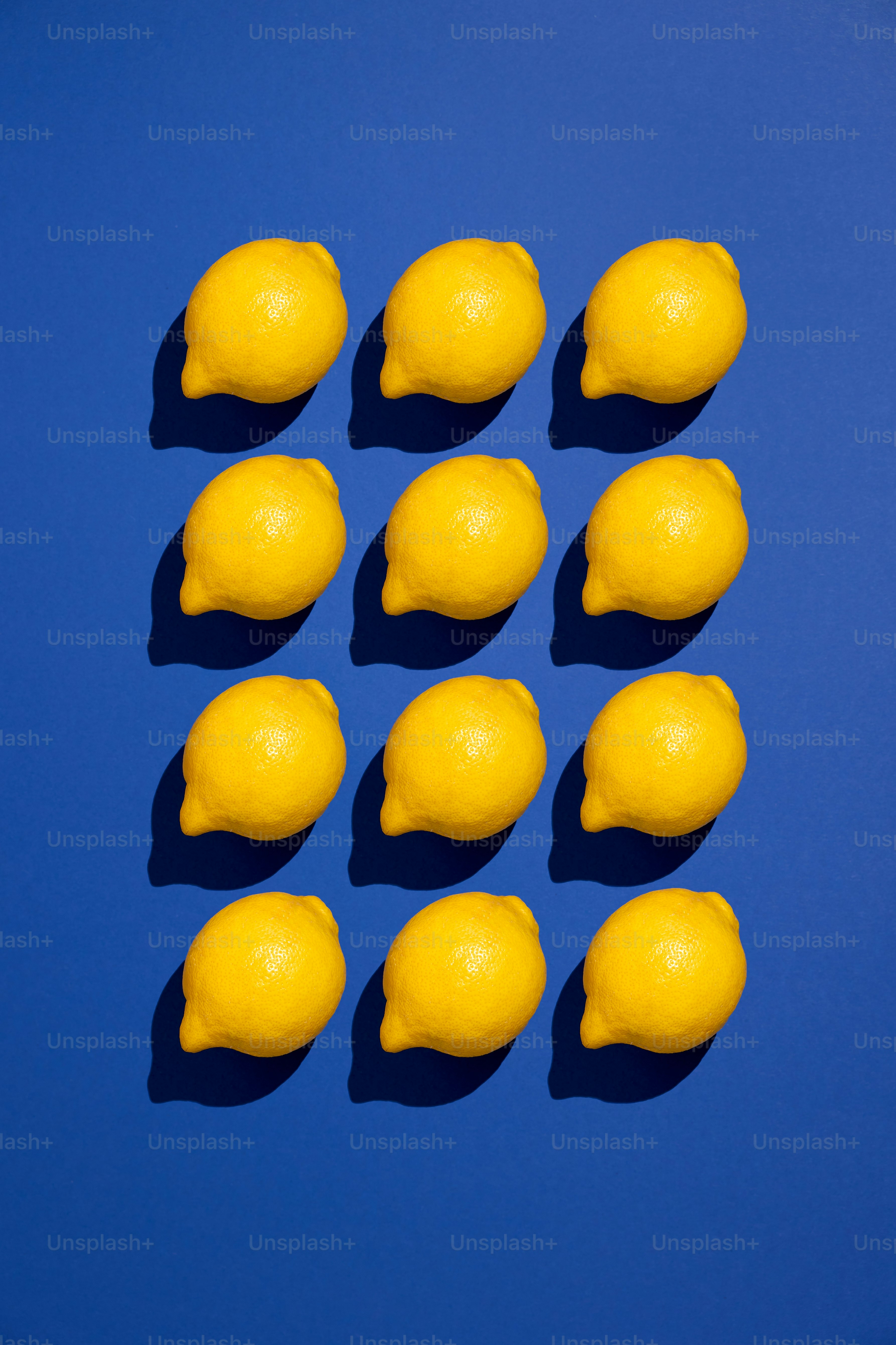 Lemons arranged in a grid on a blue background. photo – Yellow Image on ...