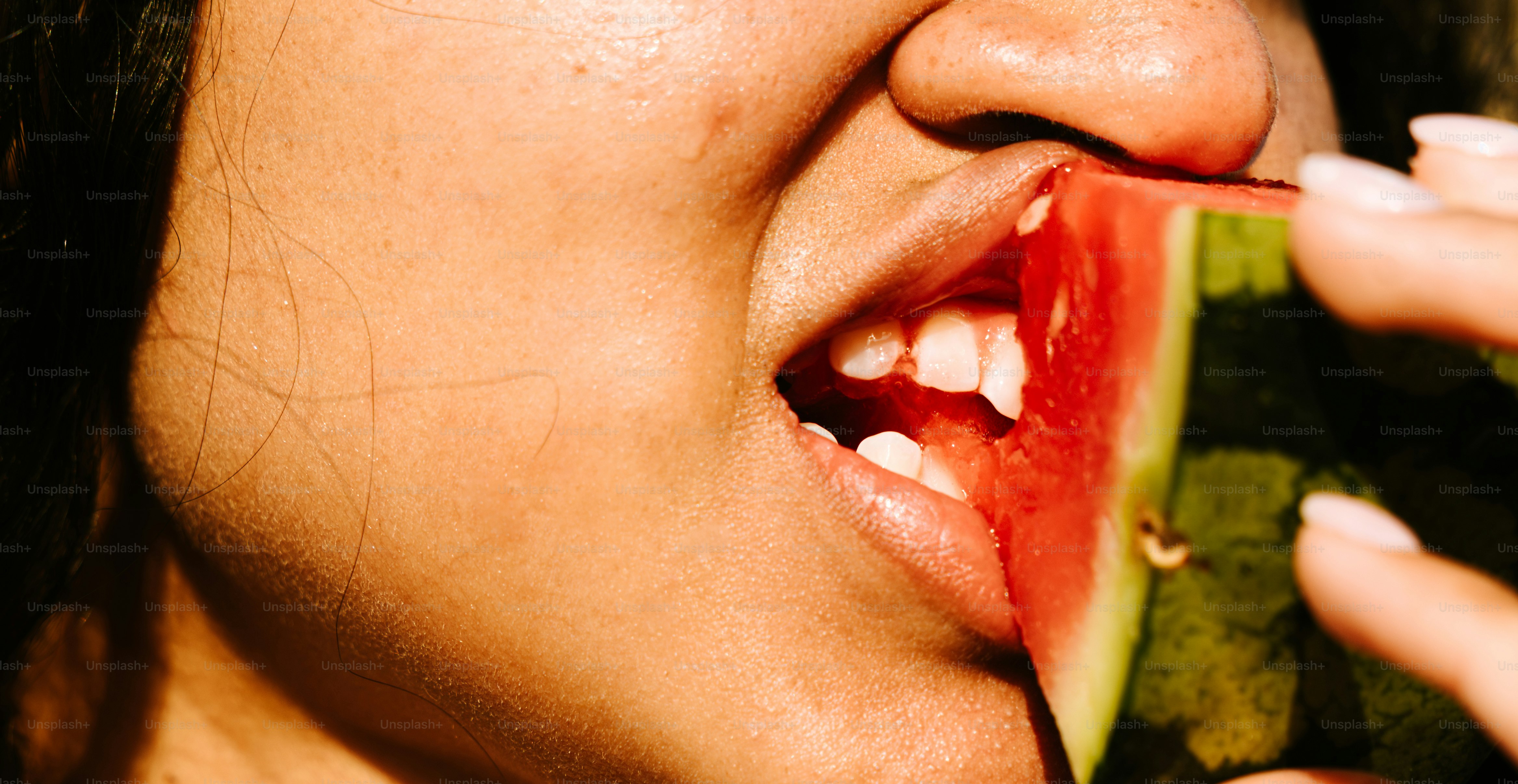 A person bites into a juicy watermelon slice. photo – Summer Image on ...
