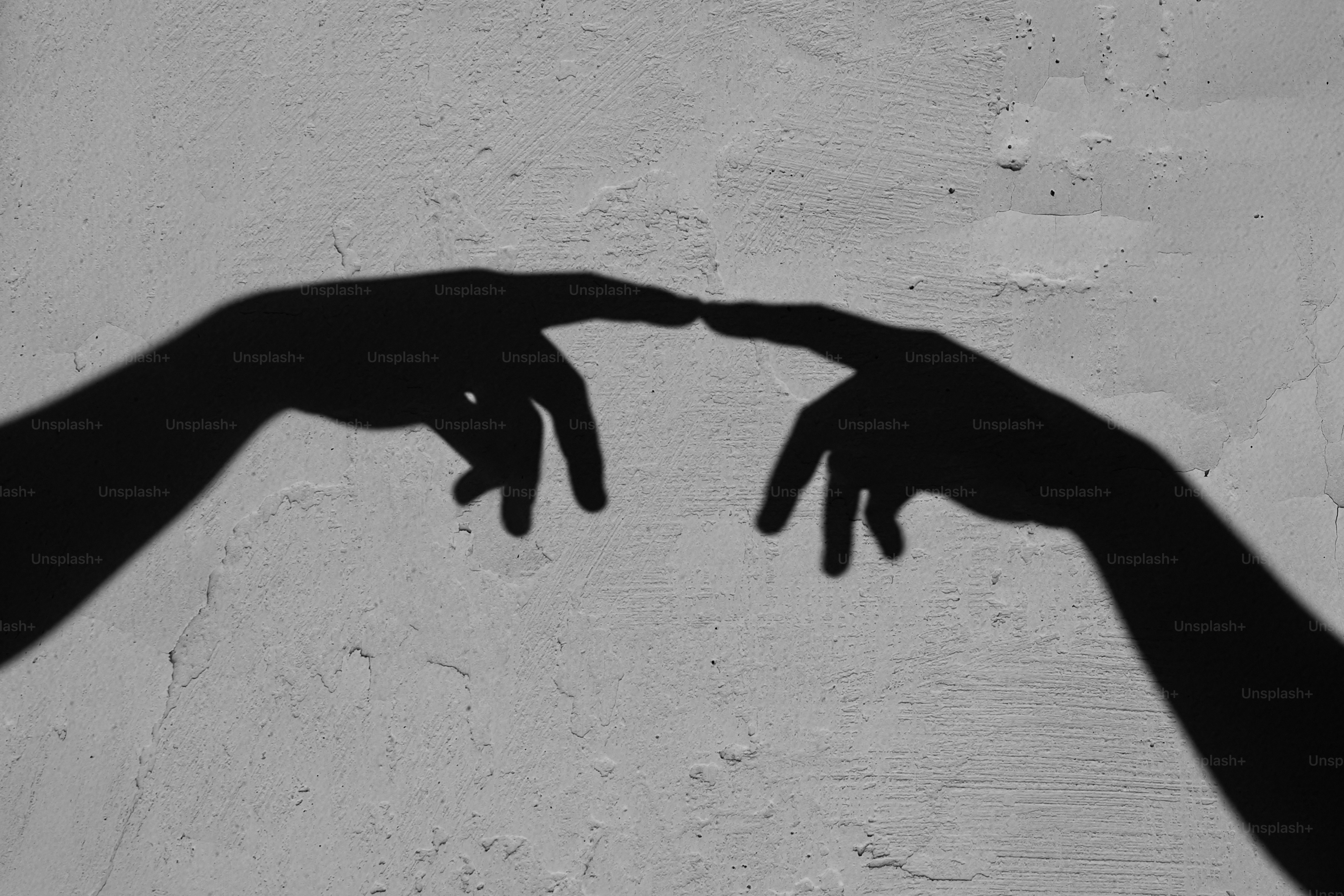 Shadows of hands almost touching. photo – Abstract Image on Unsplash