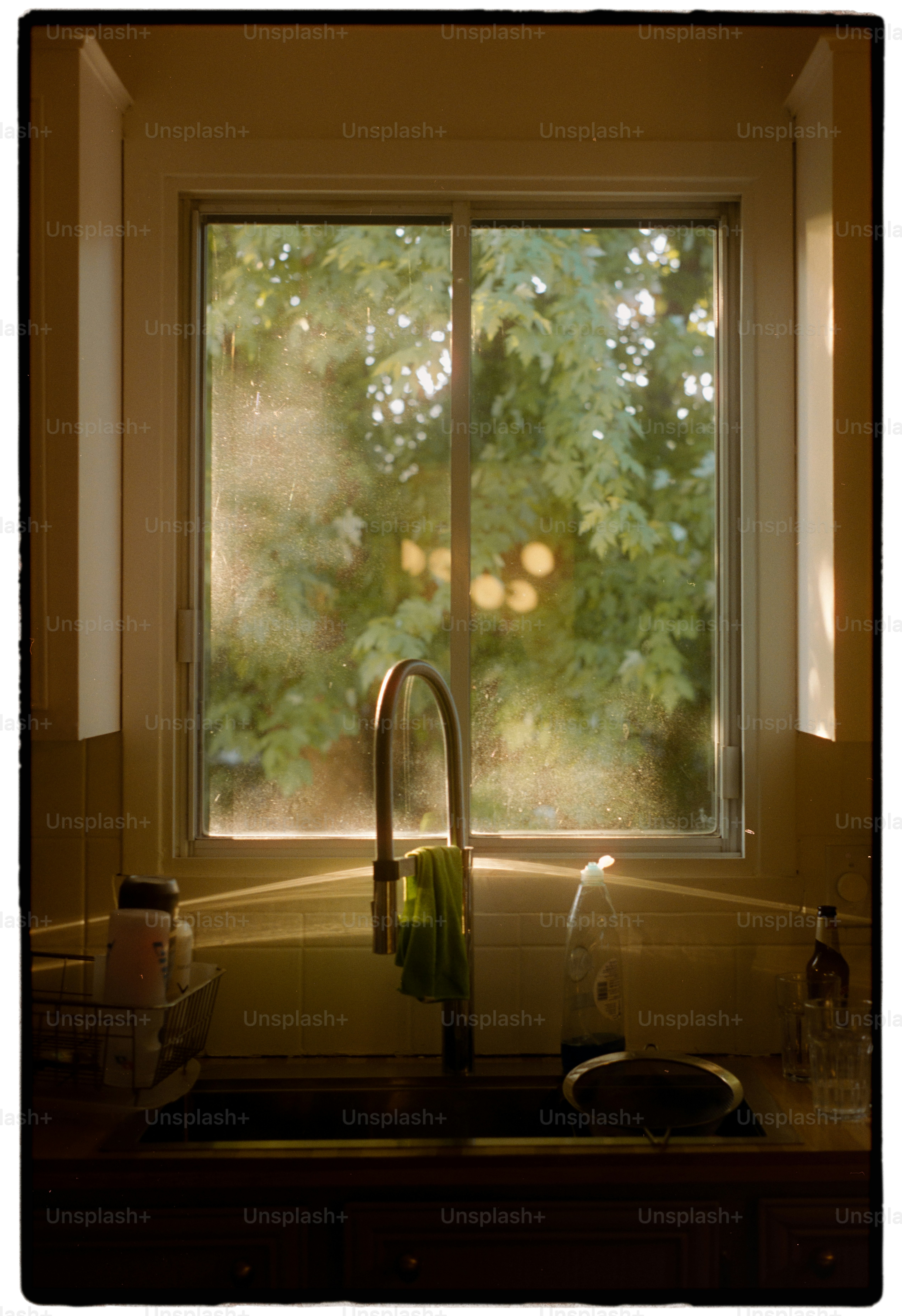 Sunlight streams through a kitchen window. photo – Film Image on Unsplash