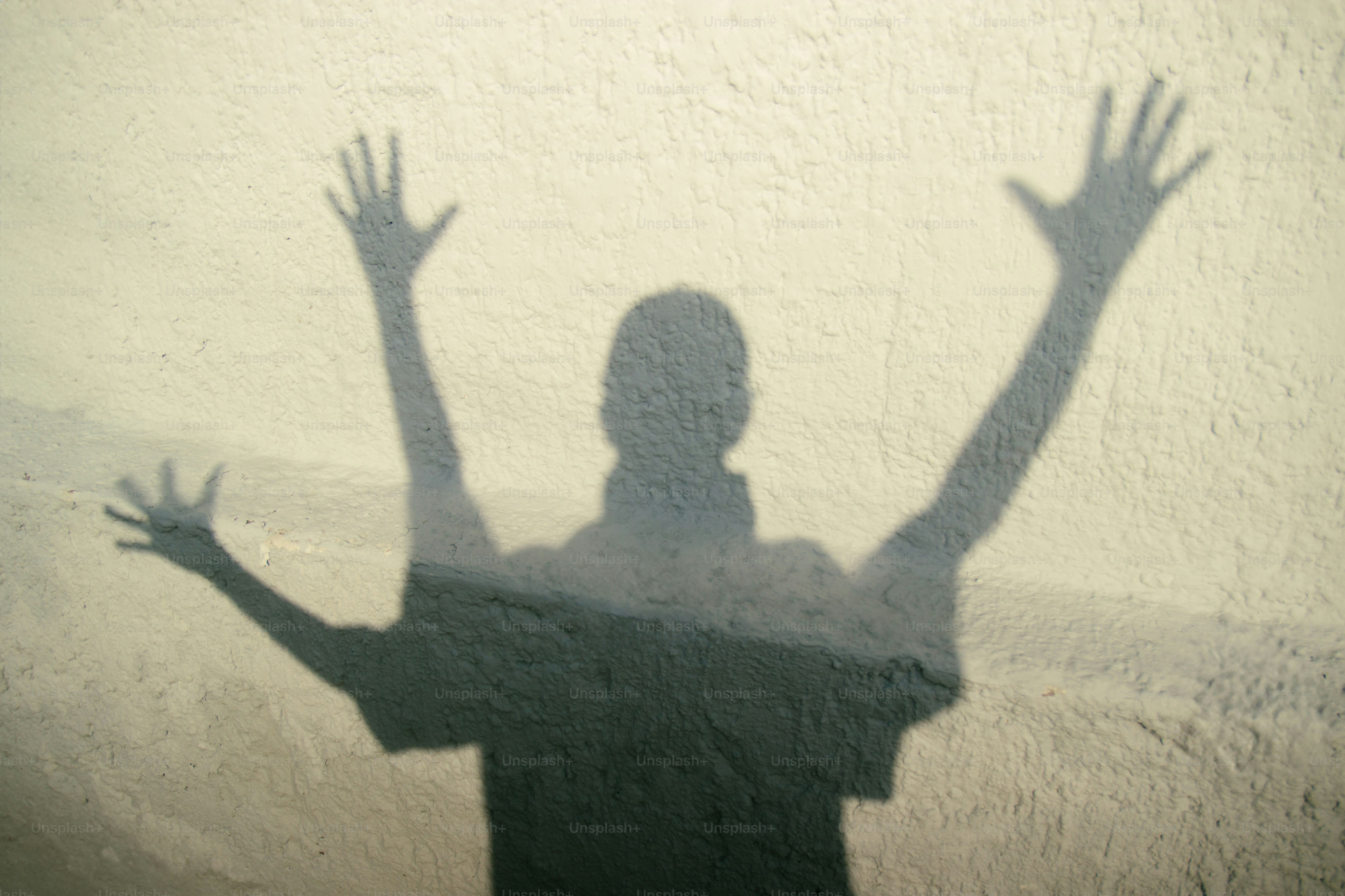 A person's shadow with arms raised. photo – Abstract Image on Unsplash