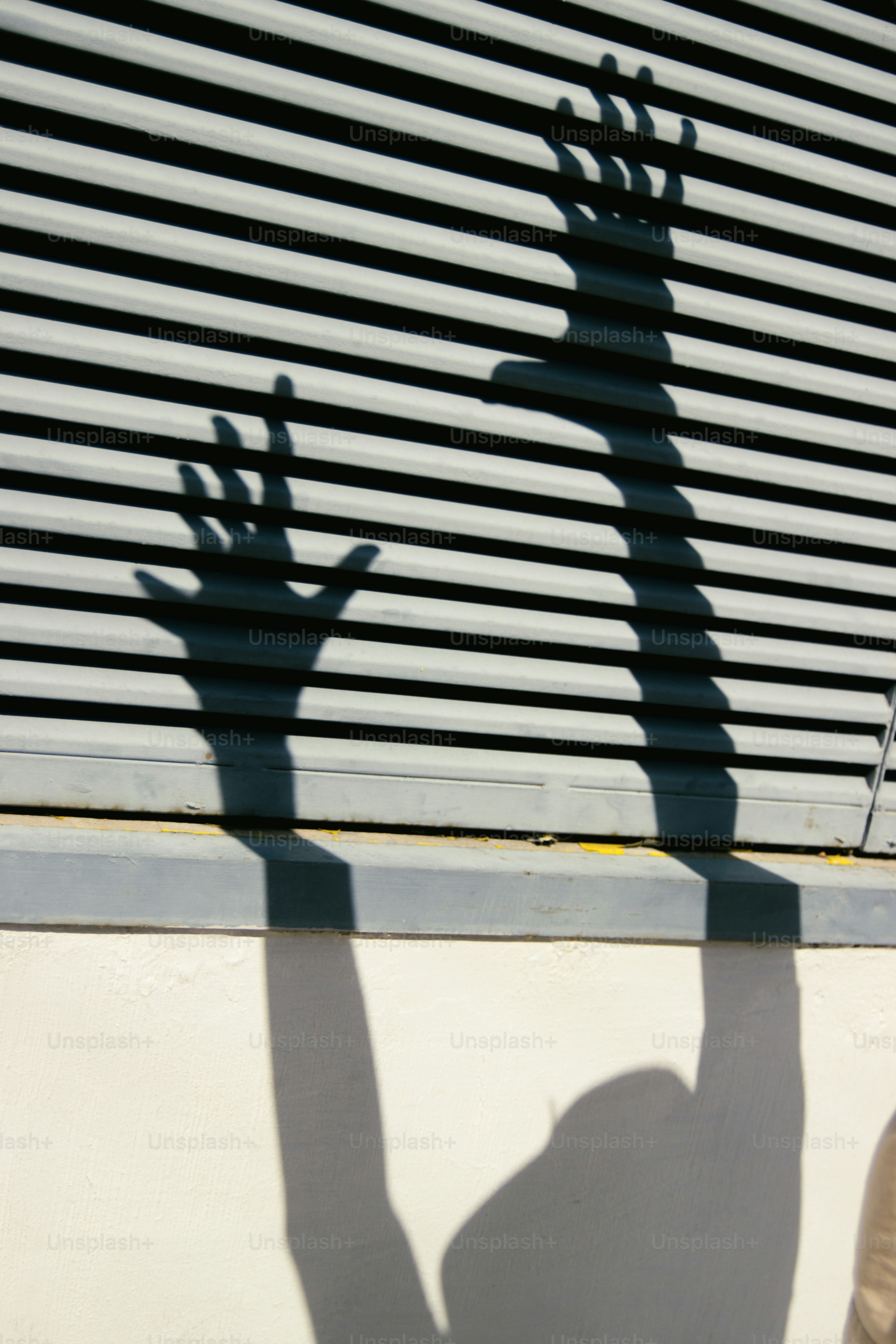 Hand shadows dance on a building's surface. photo – Abstract Image on ...