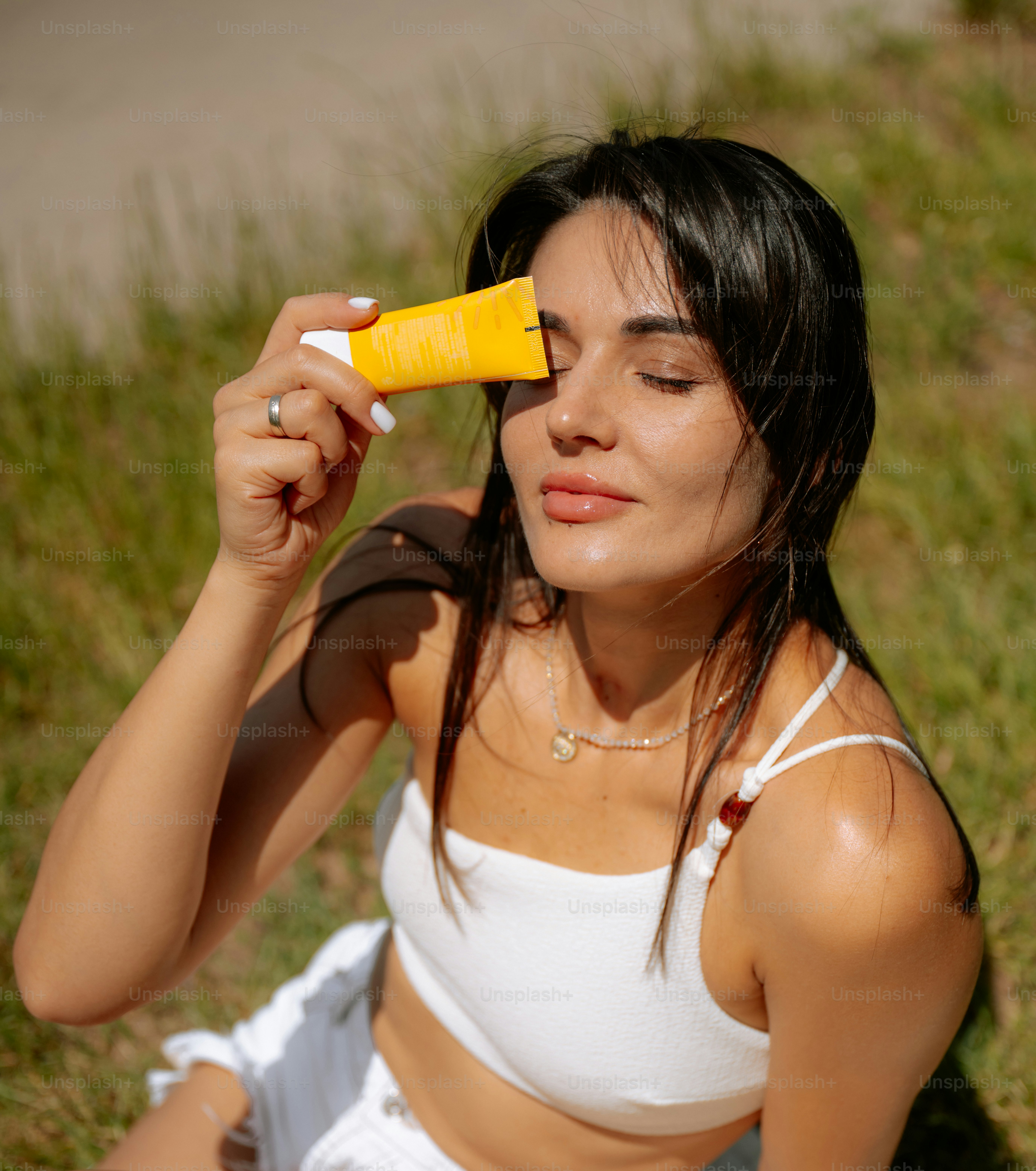 Woman protects her eyes with sunscreen. photo – Skincare Image on Unsplash