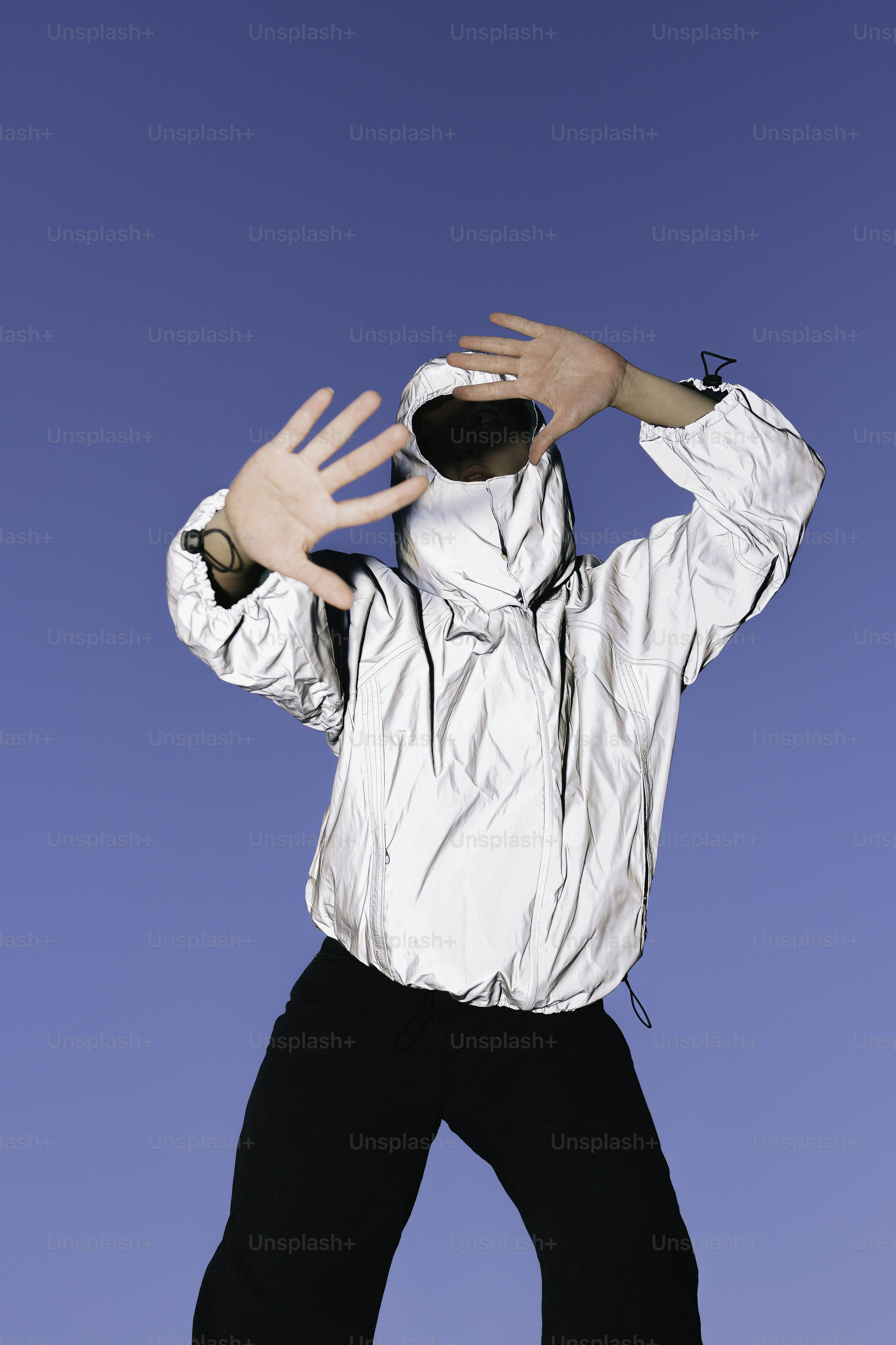 A person poses in a reflective jacket. photo – Portrait Image on Unsplash