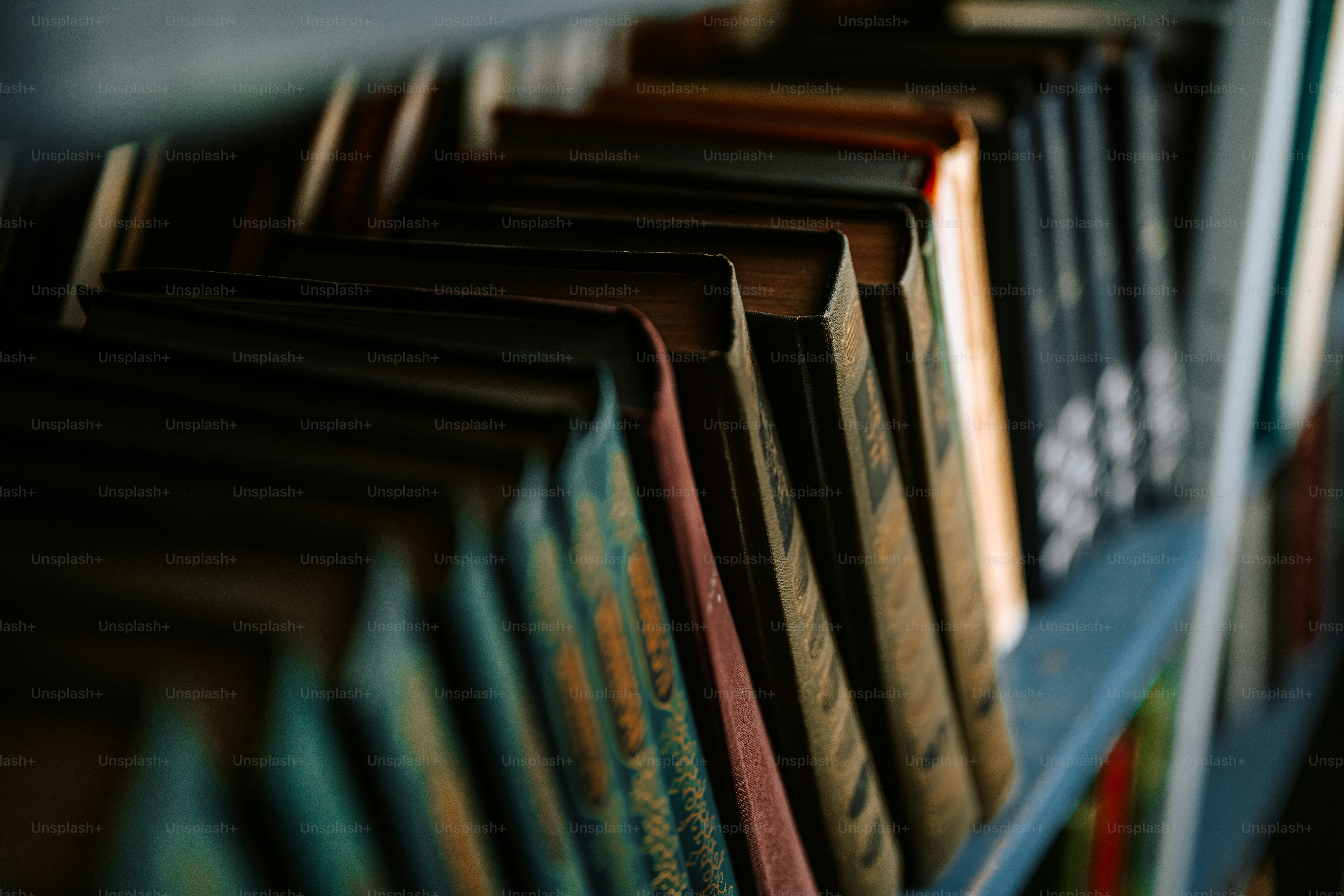 Books are stacked on a library table. photo – Green Image on Unsplash