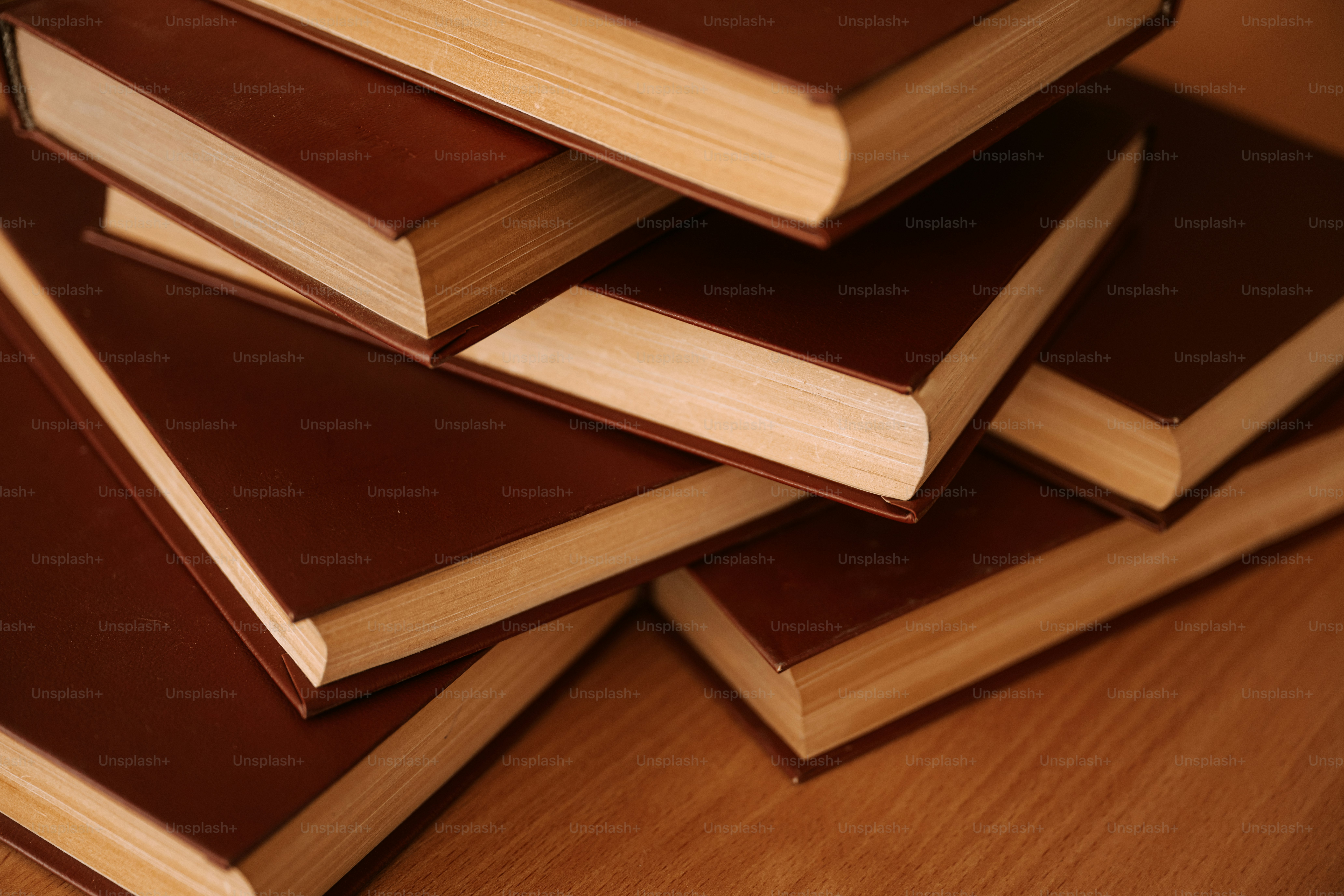 Here is a caption for the image: several old books are stacked together ...