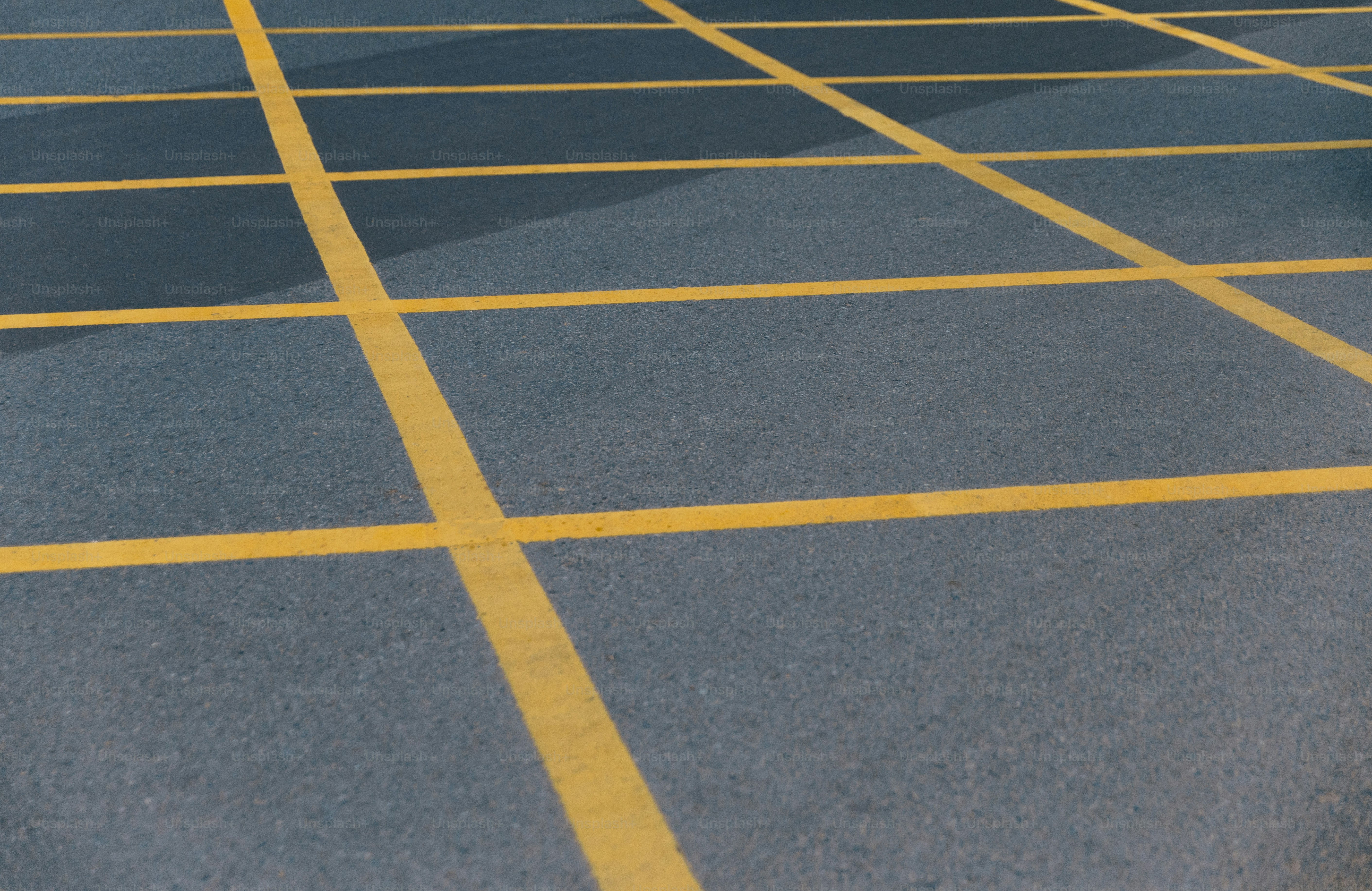 Yellow lines create a grid on the asphalt. photo – Architecture Image ...