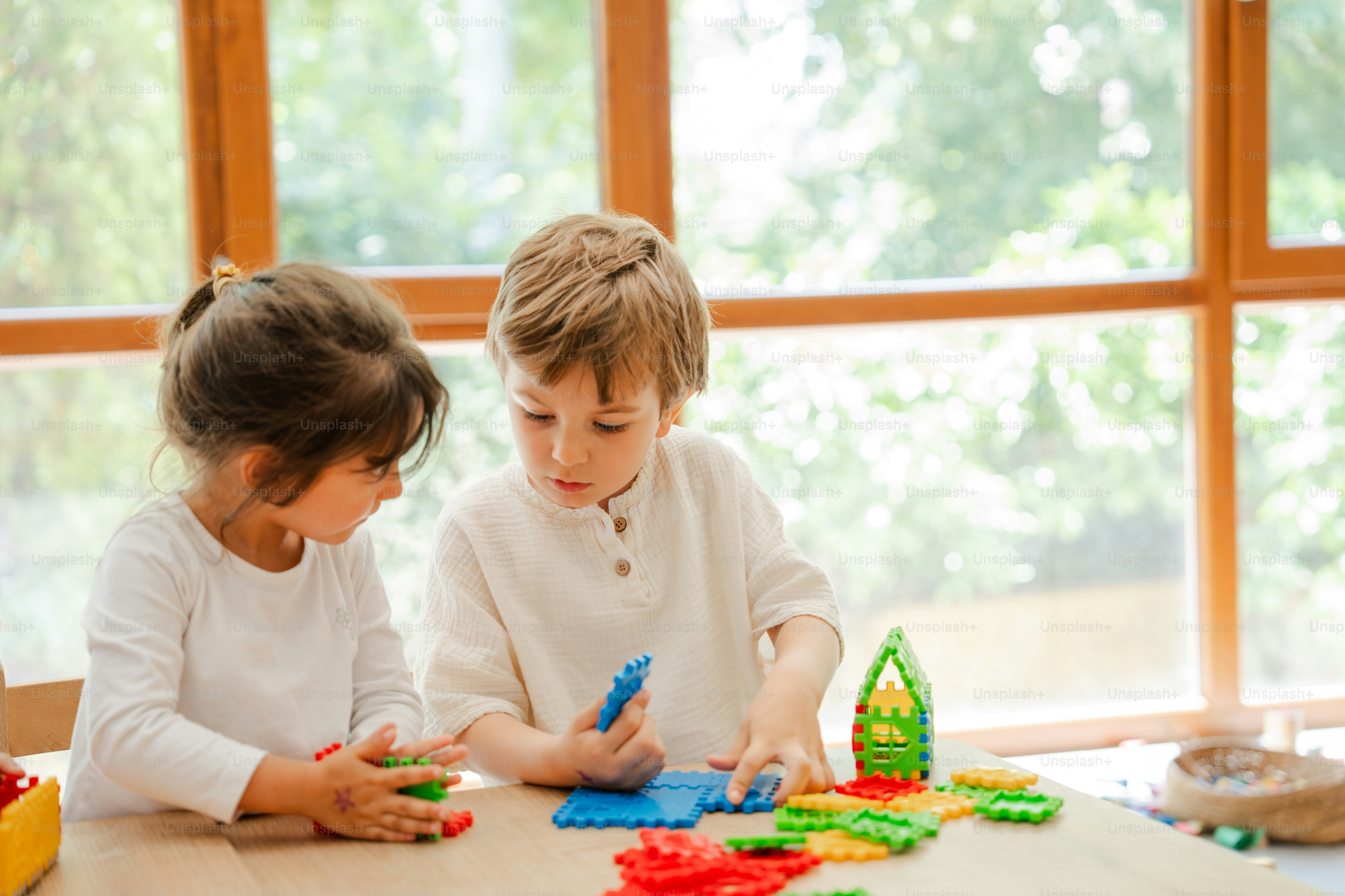 Two children play with colorful building blocks. photo – Kids Image on ...