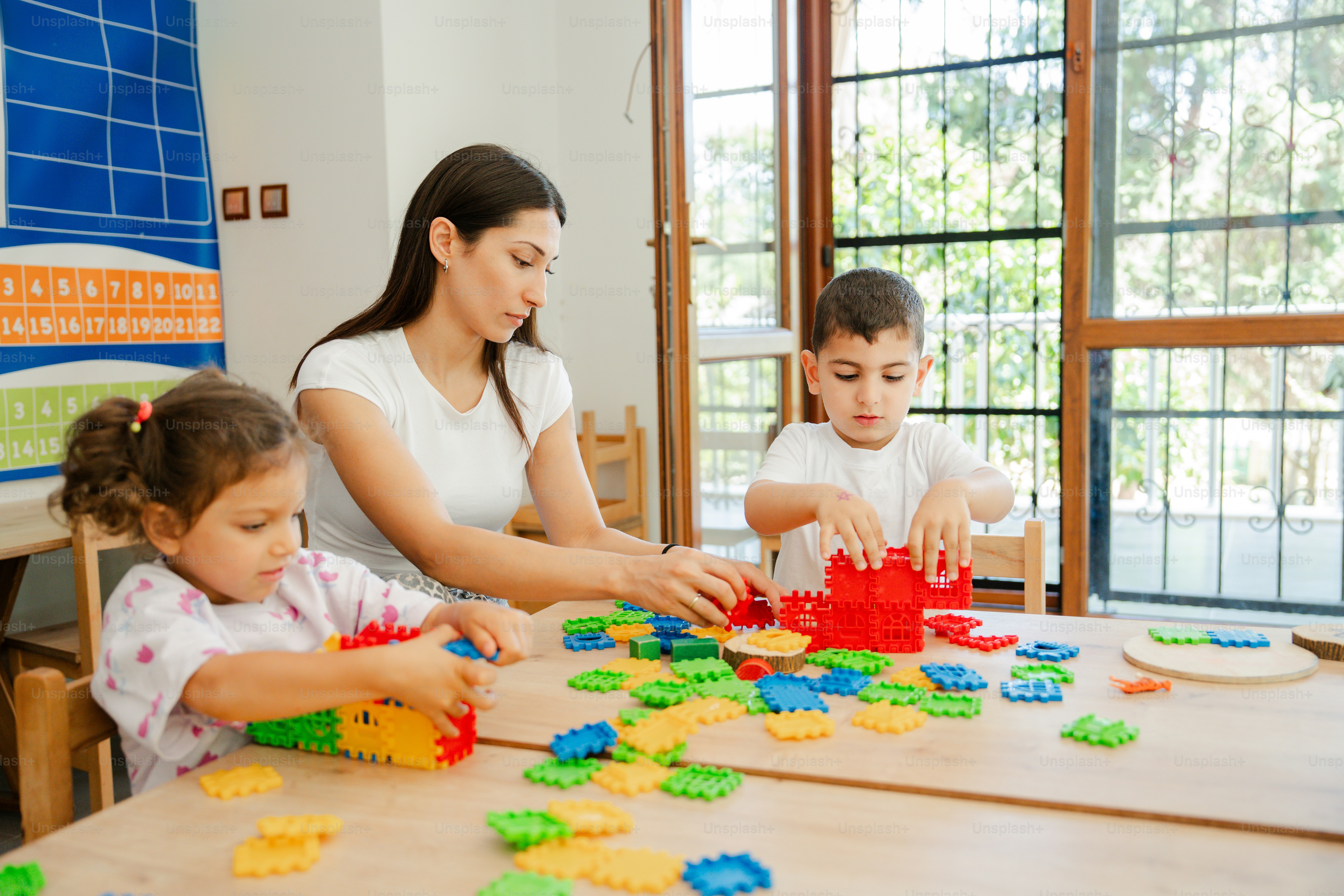 Two children play with colorful building blocks. photo – Kids Image on ...