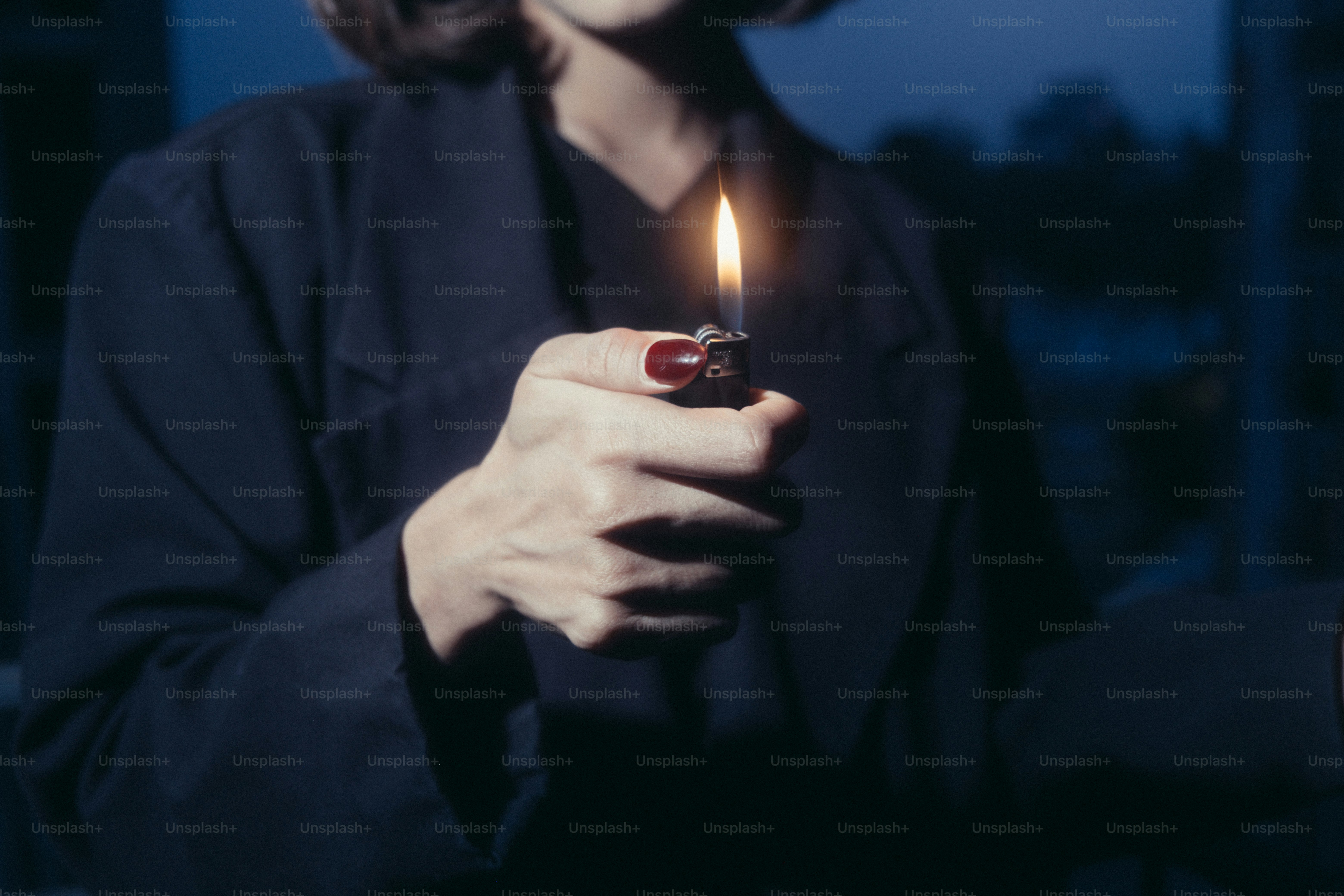 A person holds a lighter in the dark. photo – Cinematic Image on Unsplash
