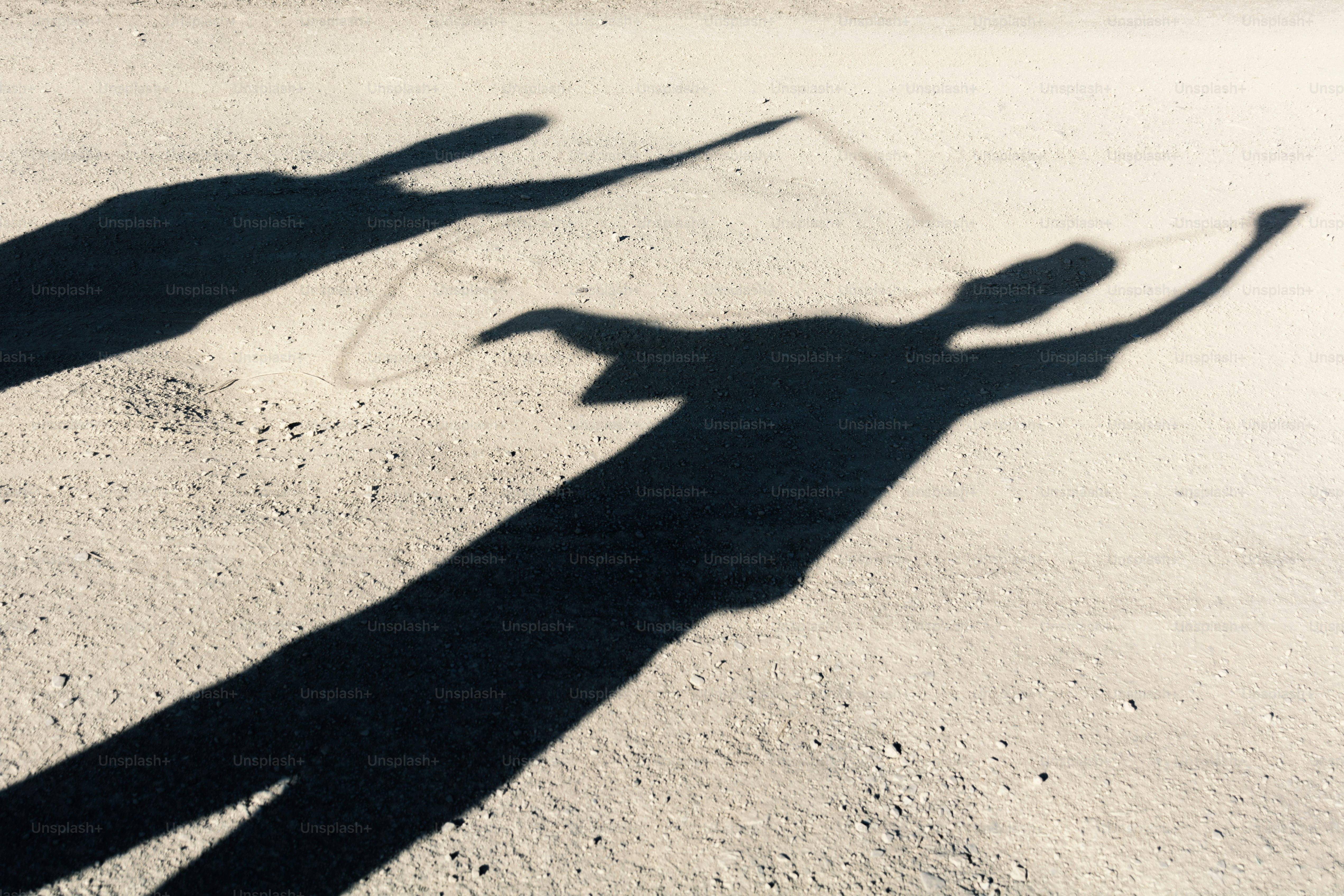 Shadows show a person jumping rope outside. photo – Abstract Image on ...