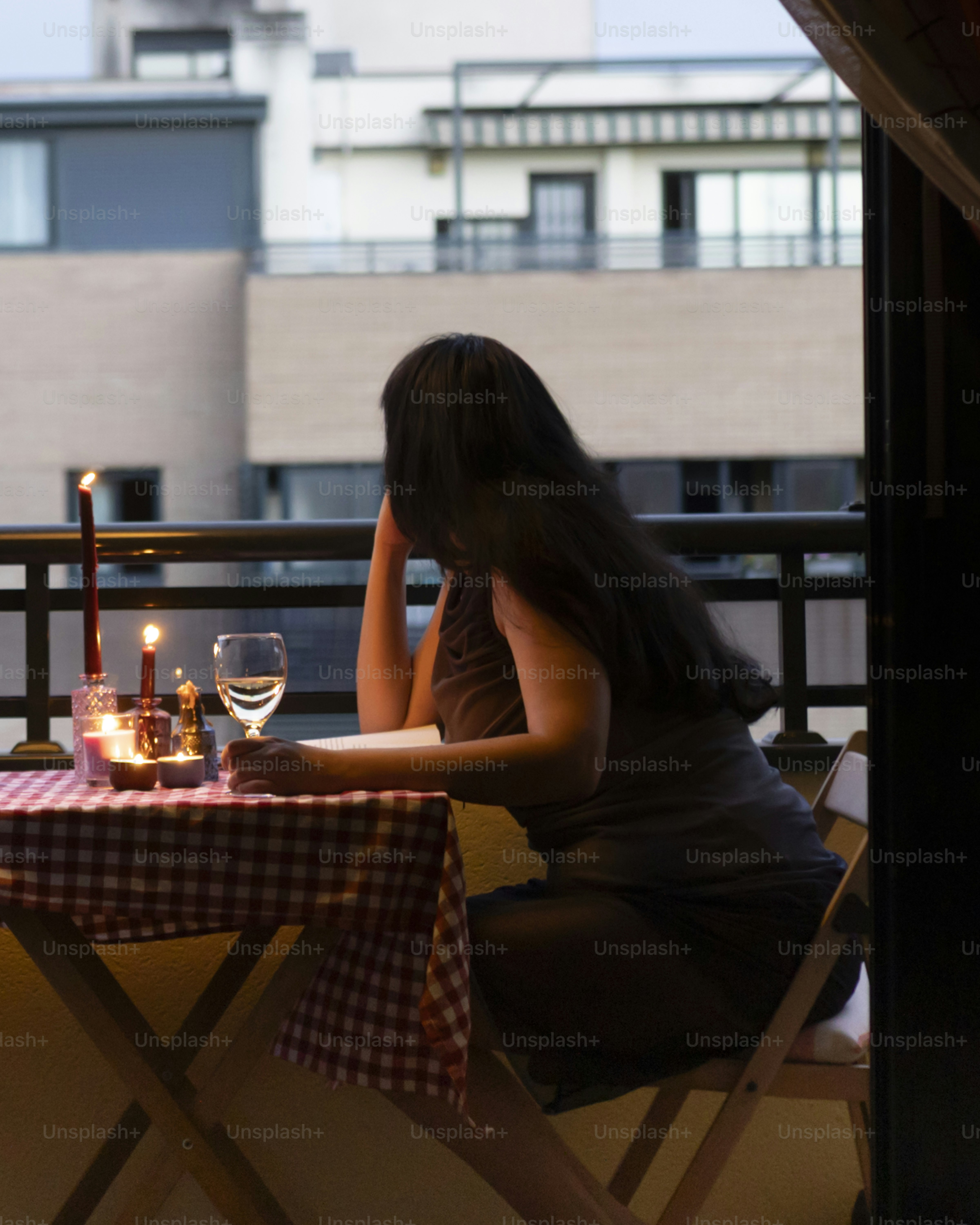 Woman enjoys a meal alone on a balcony. photo – Woman Image on Unsplash