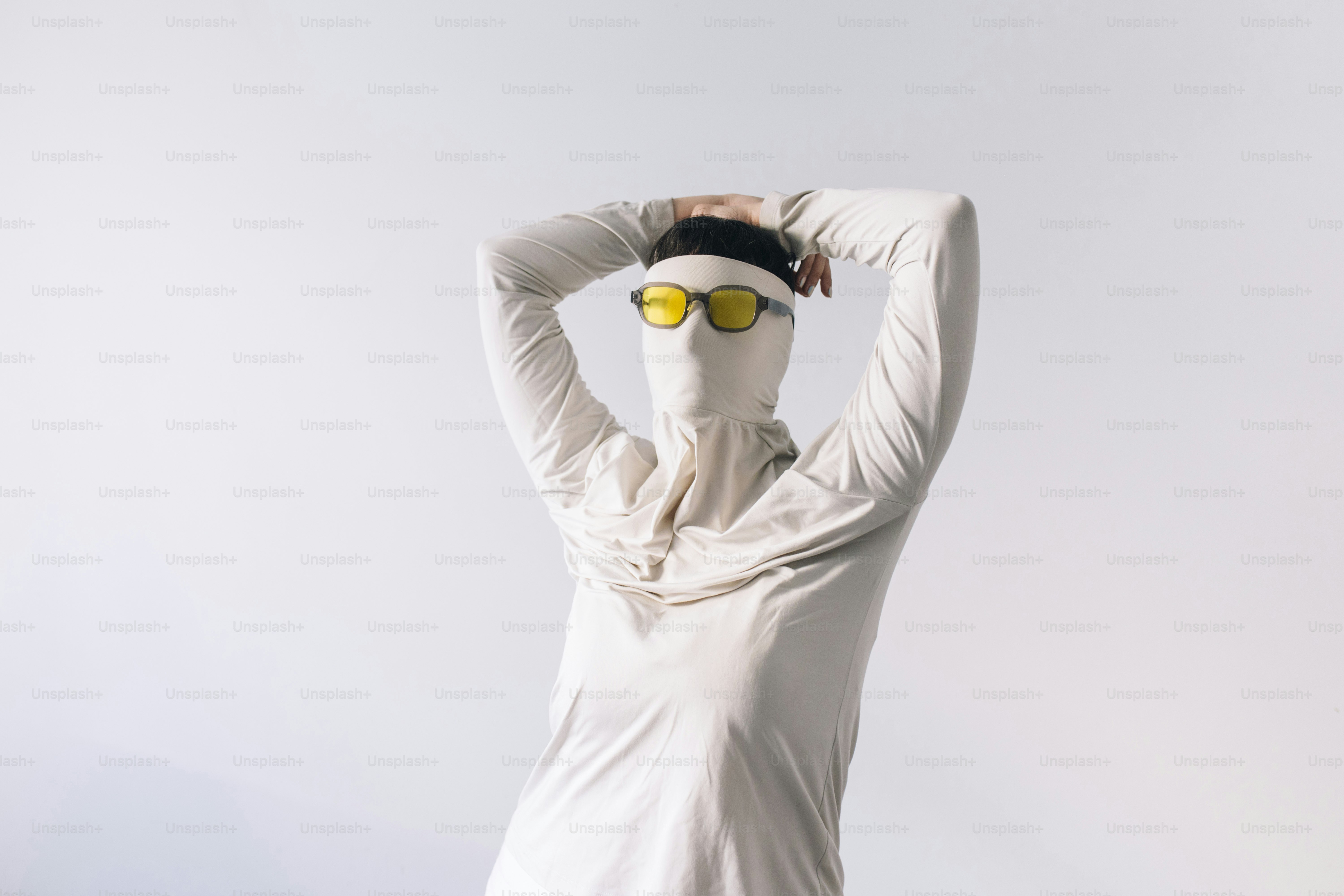 Person in full-body covering with arms raised. photo – Background Image ...