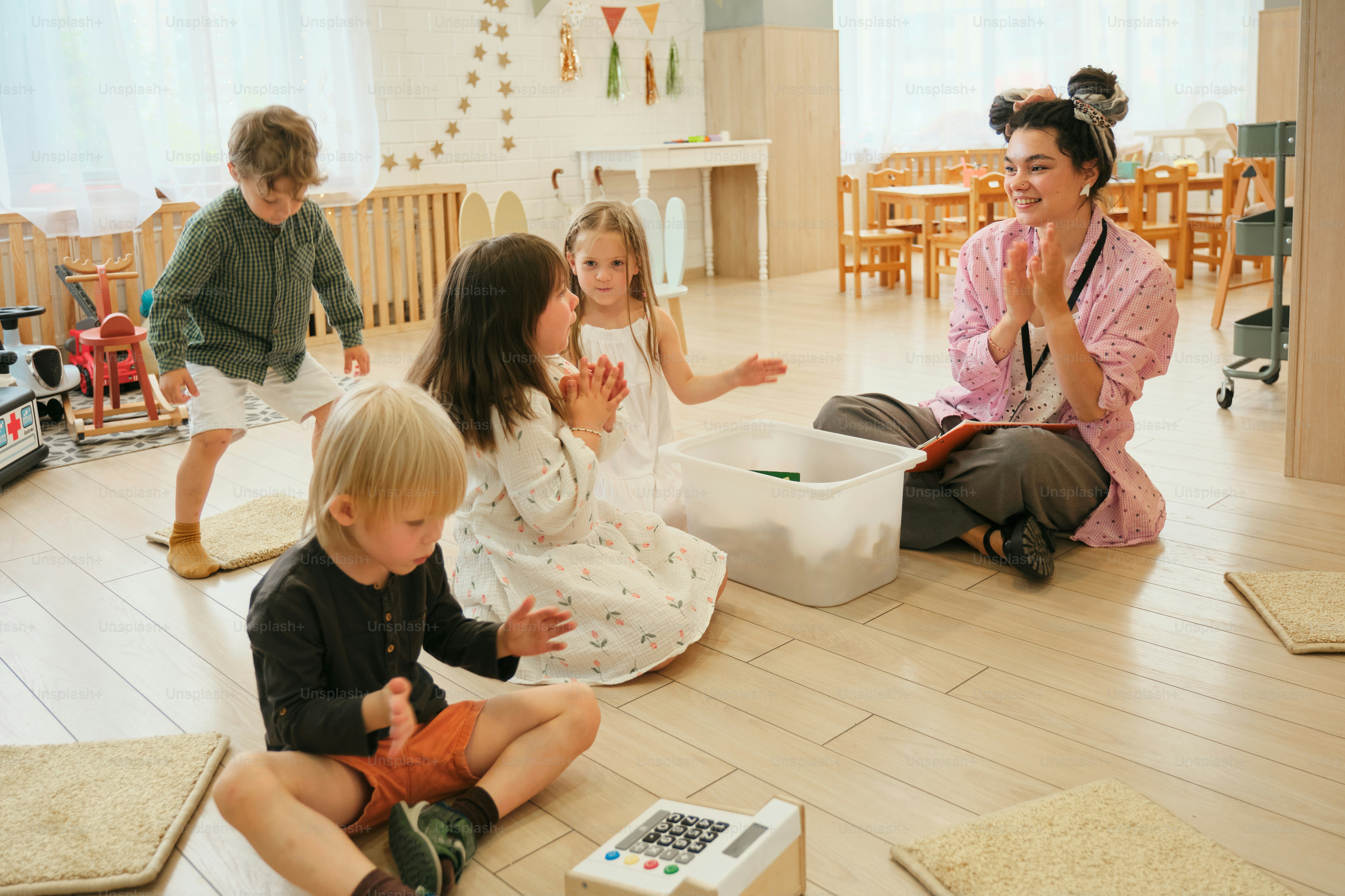 Children and a teacher clap in the classroom. photo – Kids Image on ...
