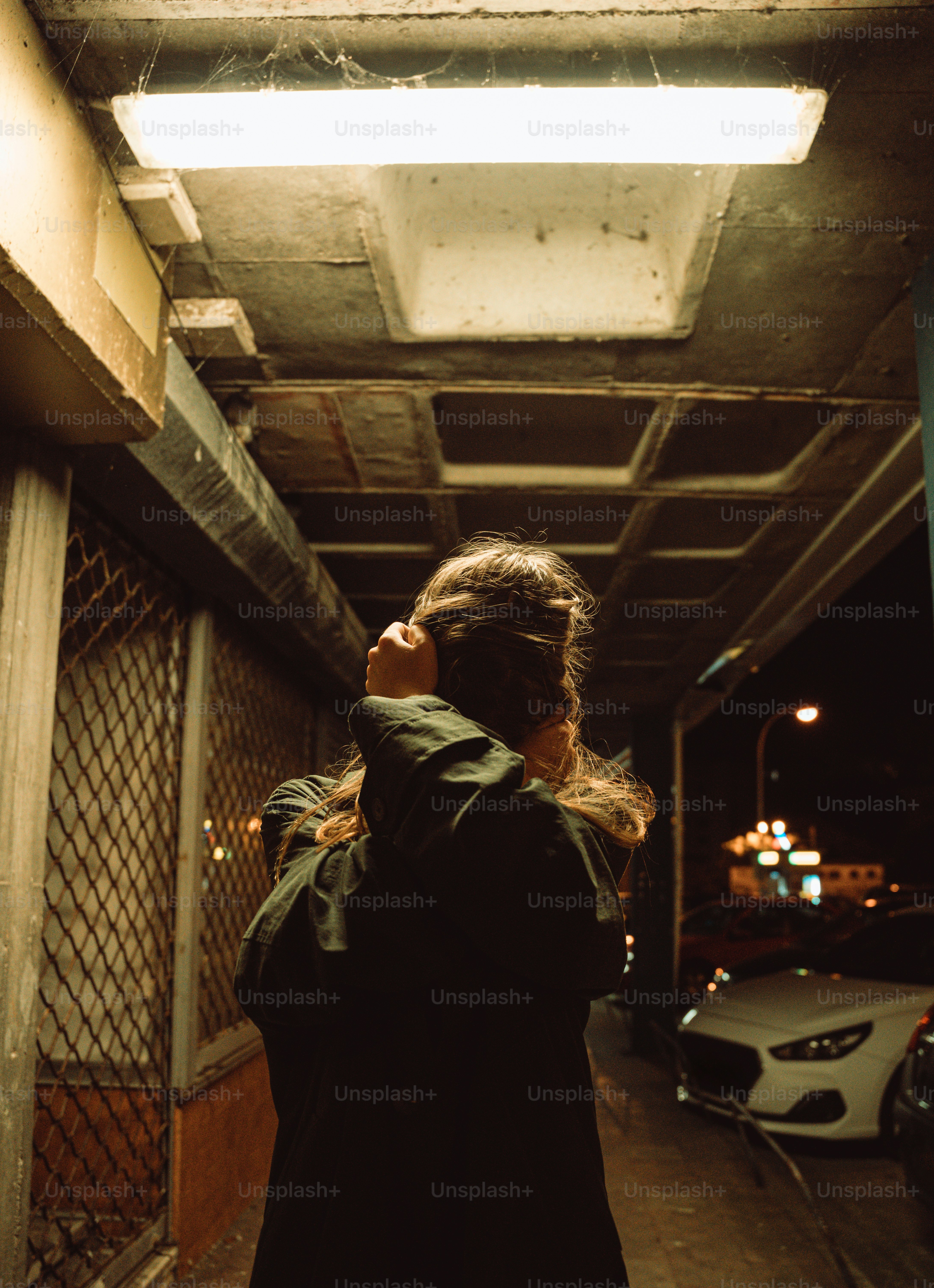 A person stands under a fluorescent light. photo – Portrait Image on ...