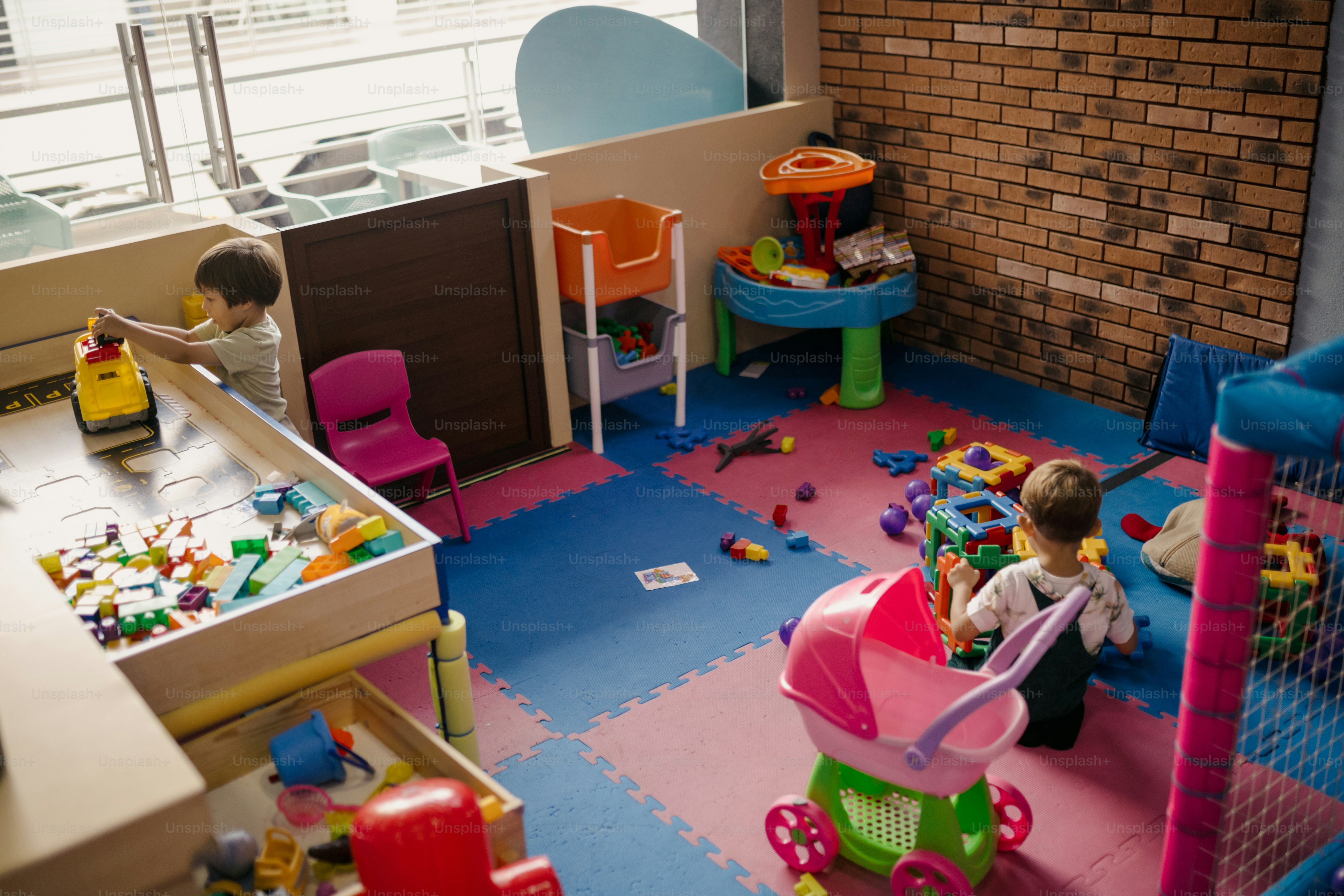 Children play in a colorful indoor playground. photo – Education Image ...