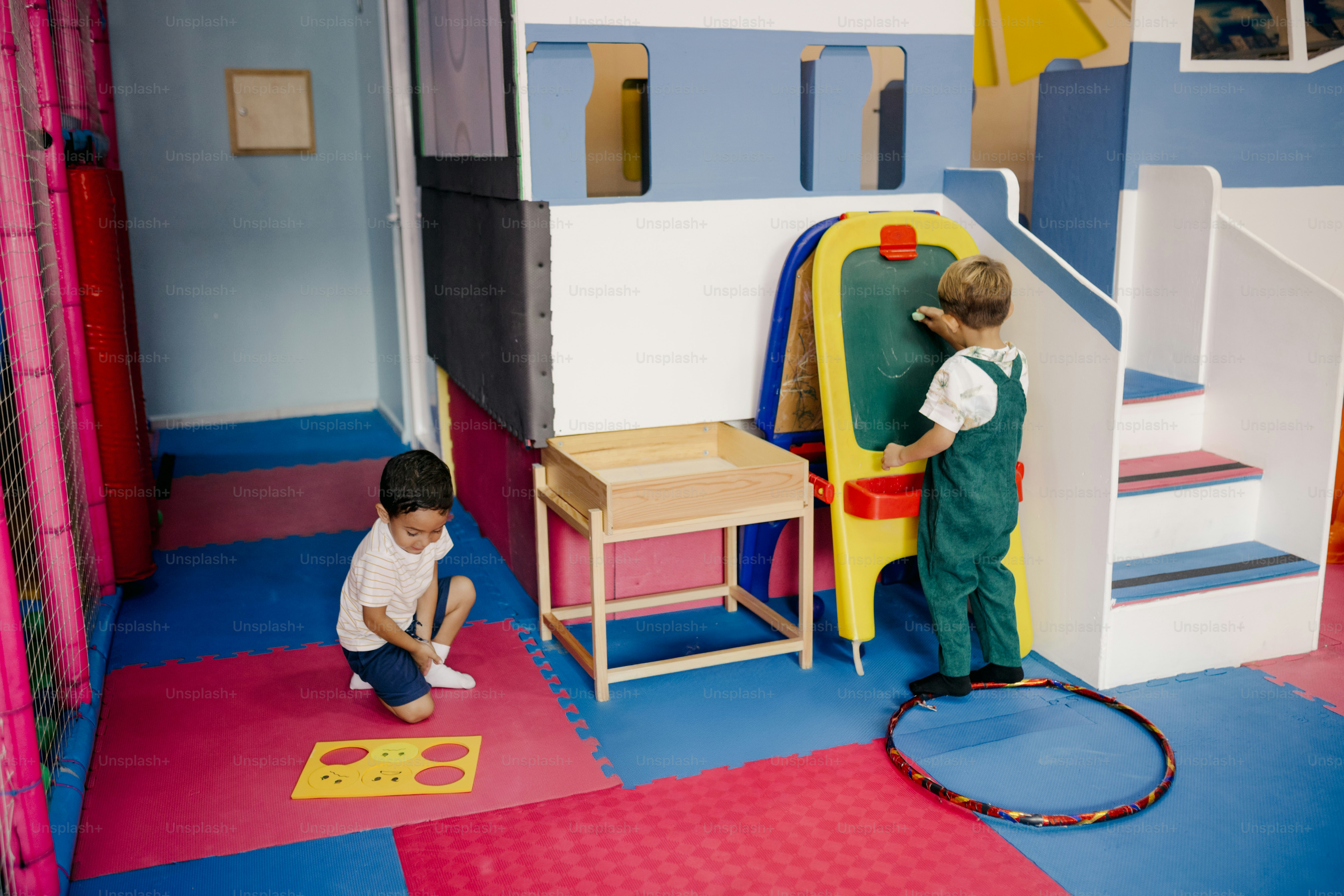 Children play in a colorful indoor playground. photo – Education Image ...