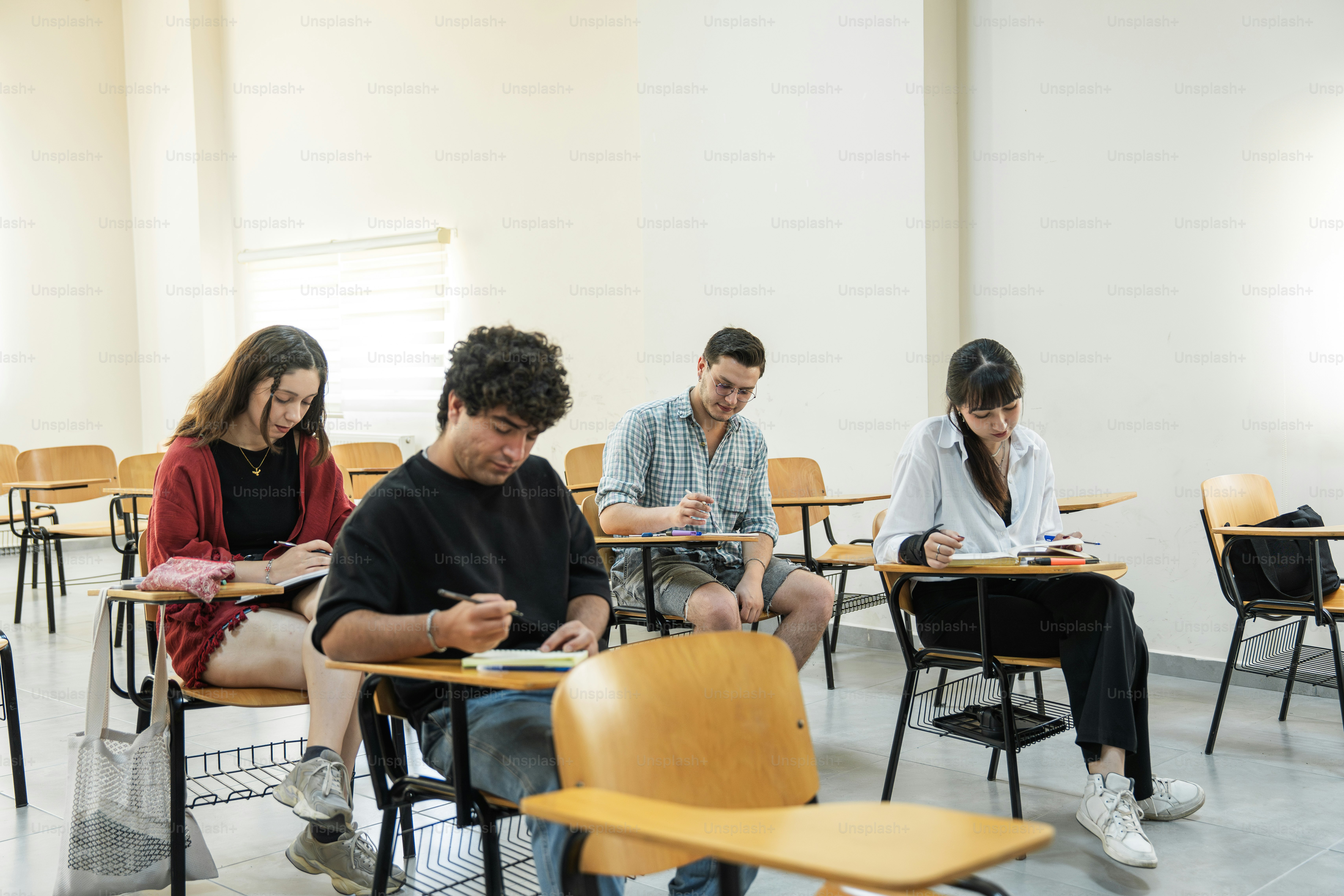 Students are seated and taking an exam. photo – Education Image on Unsplash