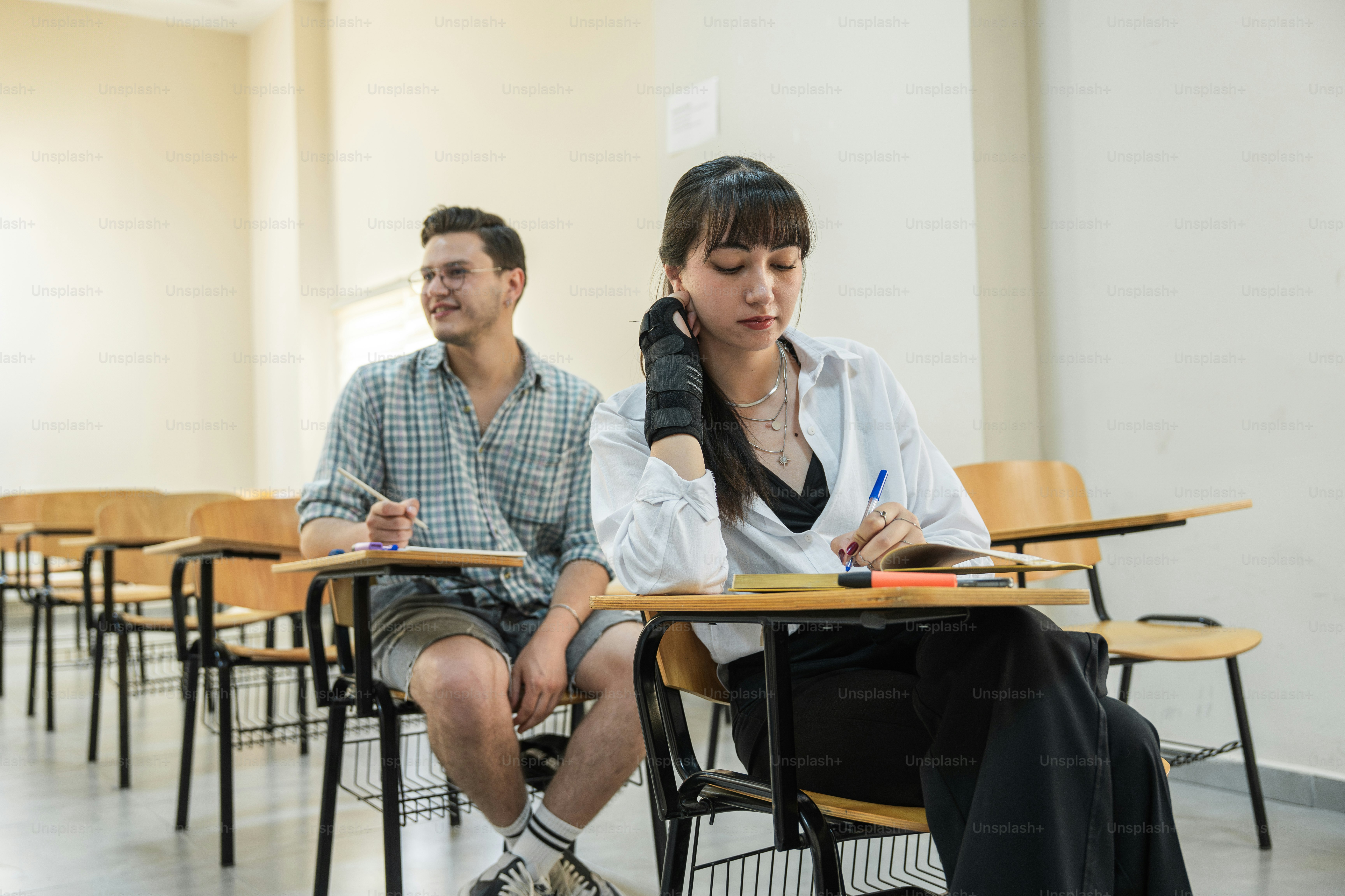Students are sitting at their desks in a classroom. photo – Education ...