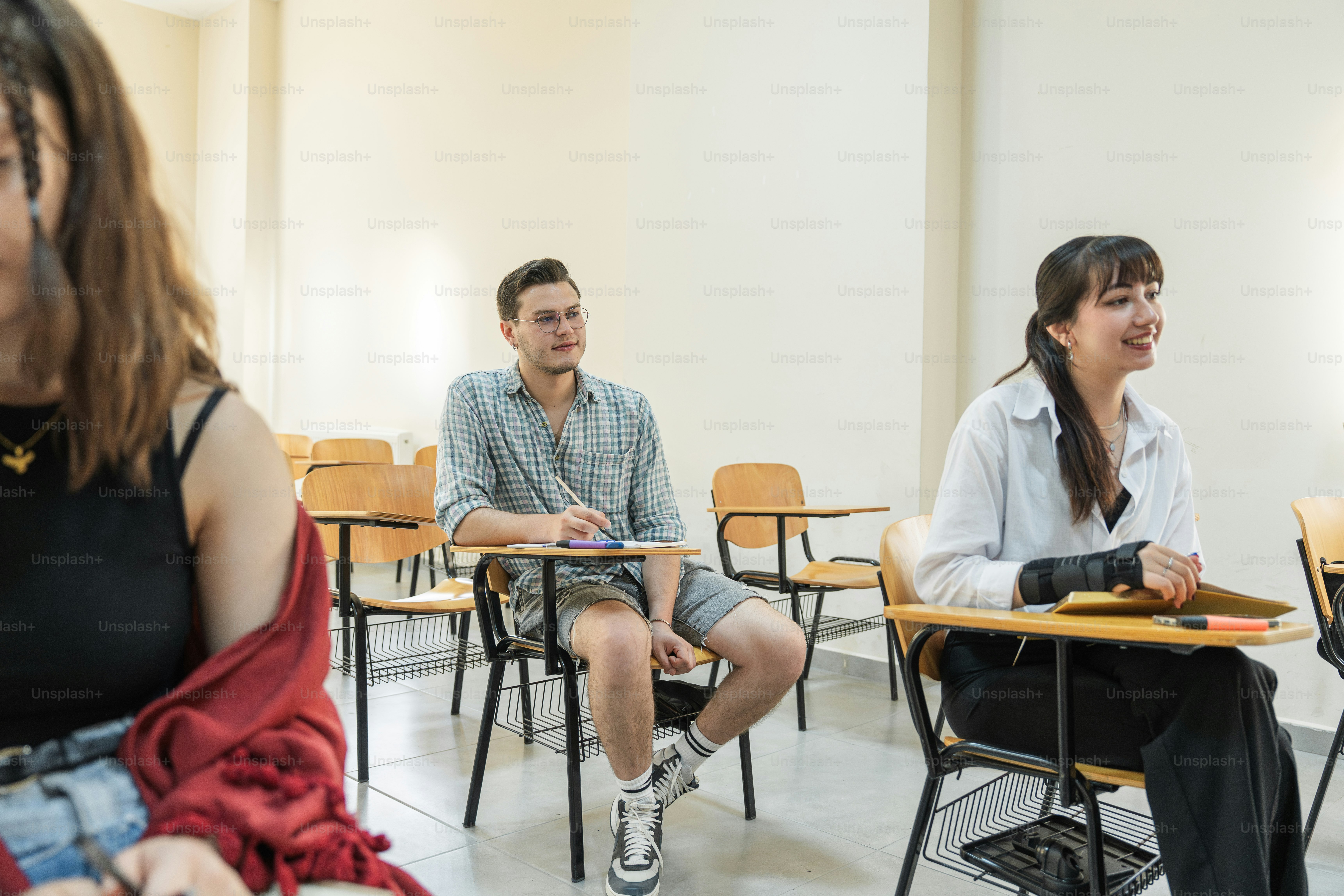 Students are sitting at their desks in a classroom. photo – Education ...